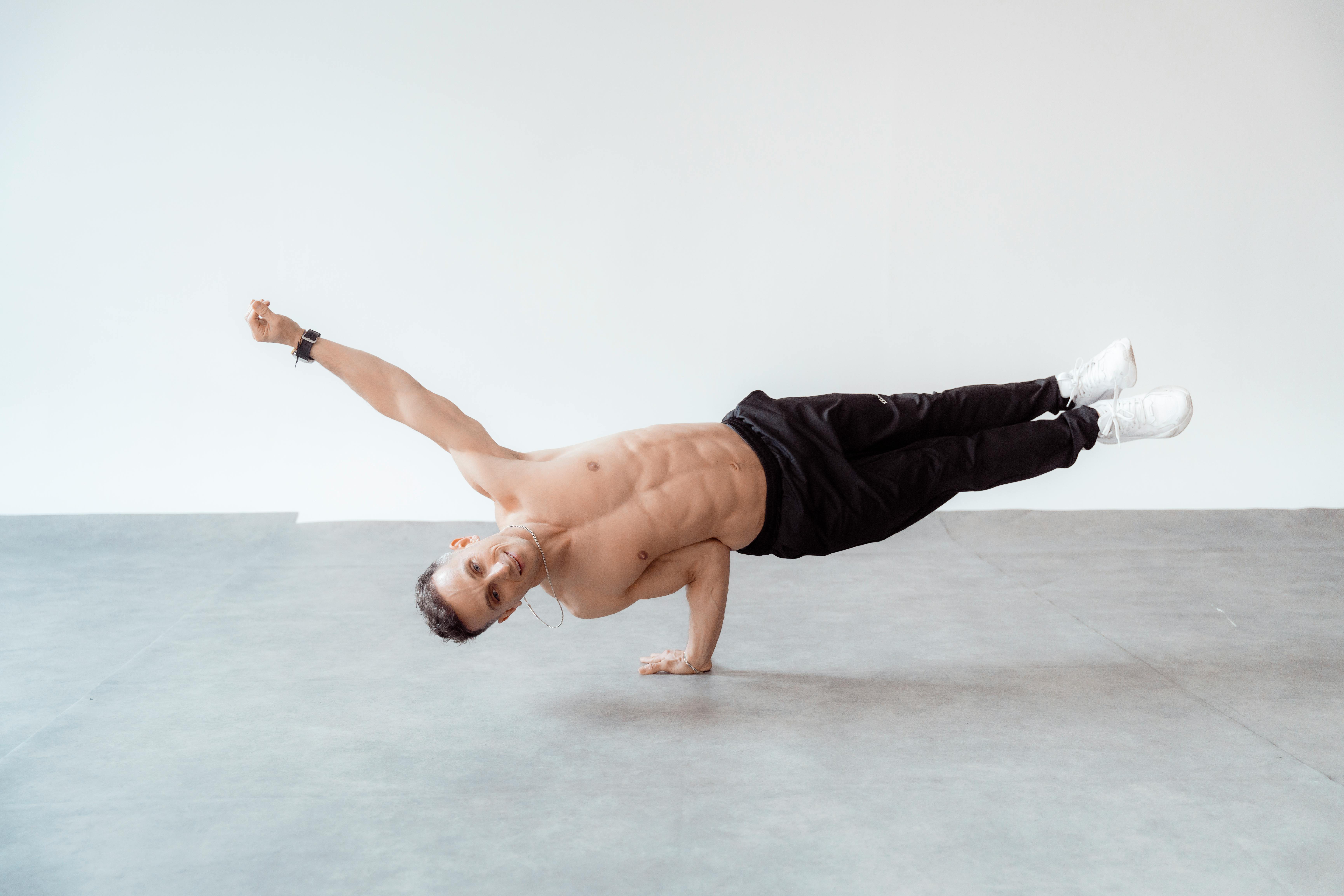 Male Breakdancer Performing a One-Handed Freeze · Free Stock Photo