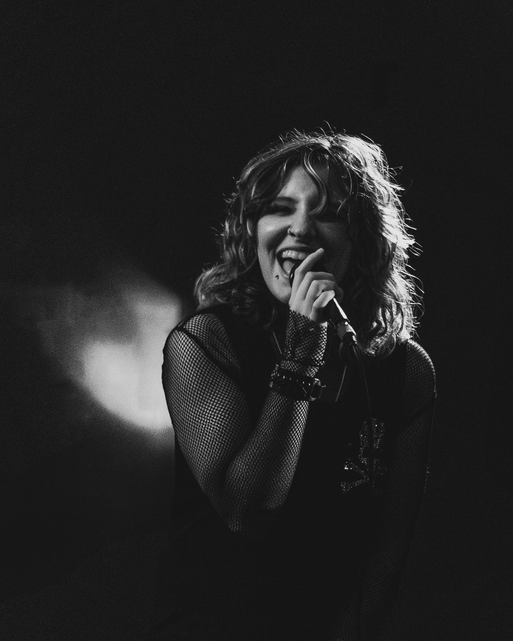 Energetic Female Rock Singer Performing Live · Free Stock Photo