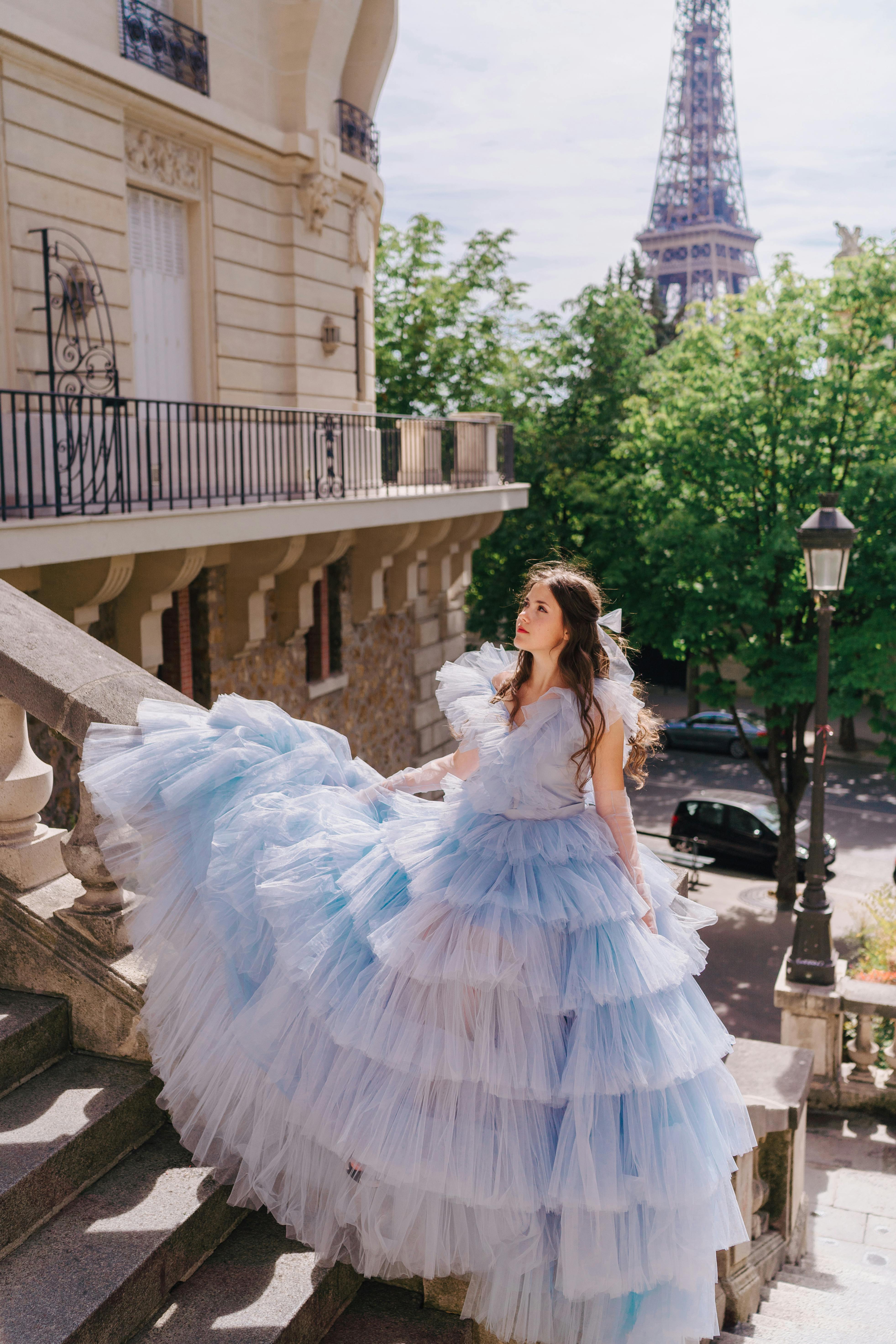 Elegant Woman in Blue Gown on Parisian Steps · Free Stock Photo
