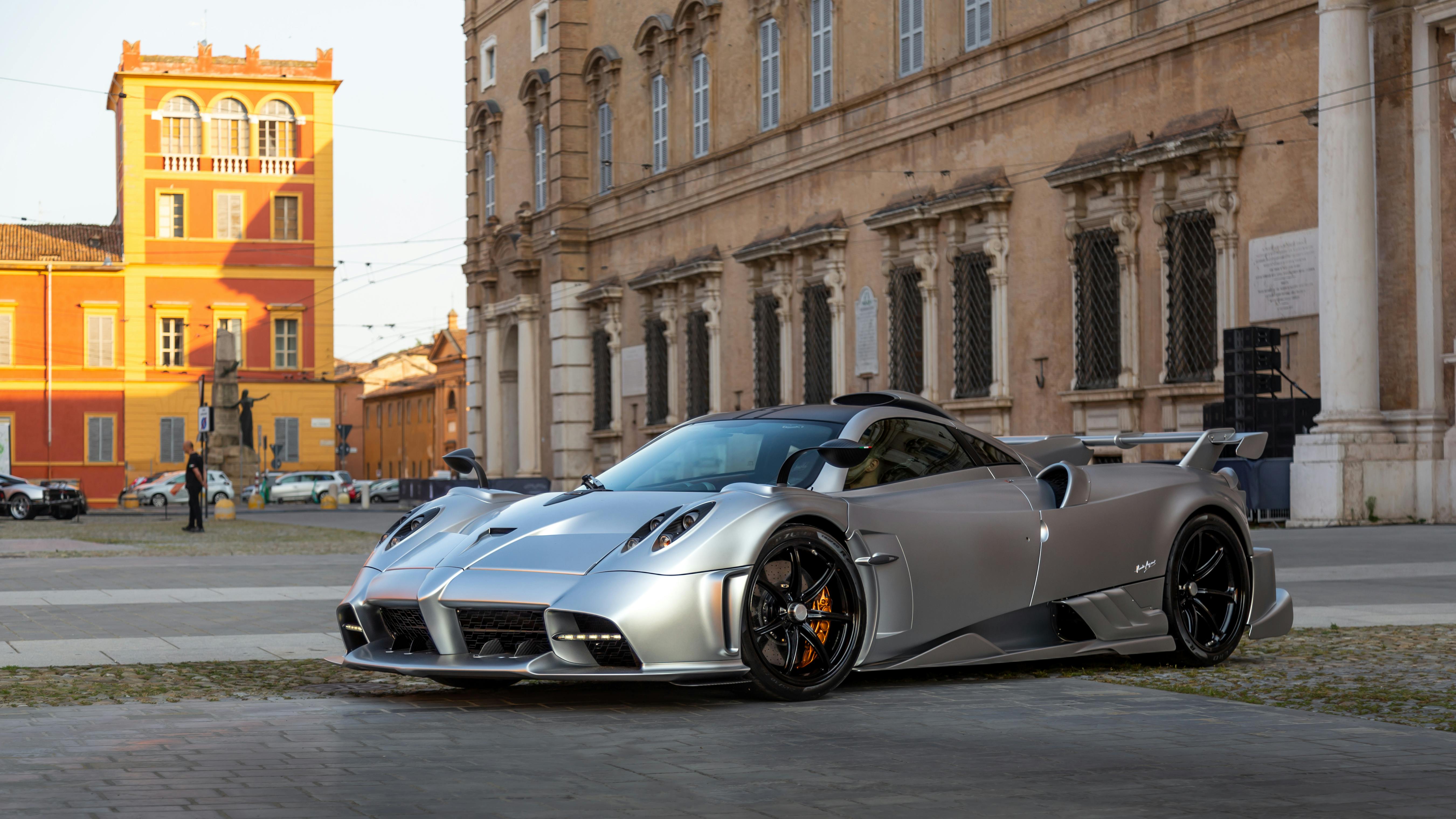 Silver Supercar in Historic European Square · Free Stock Photo