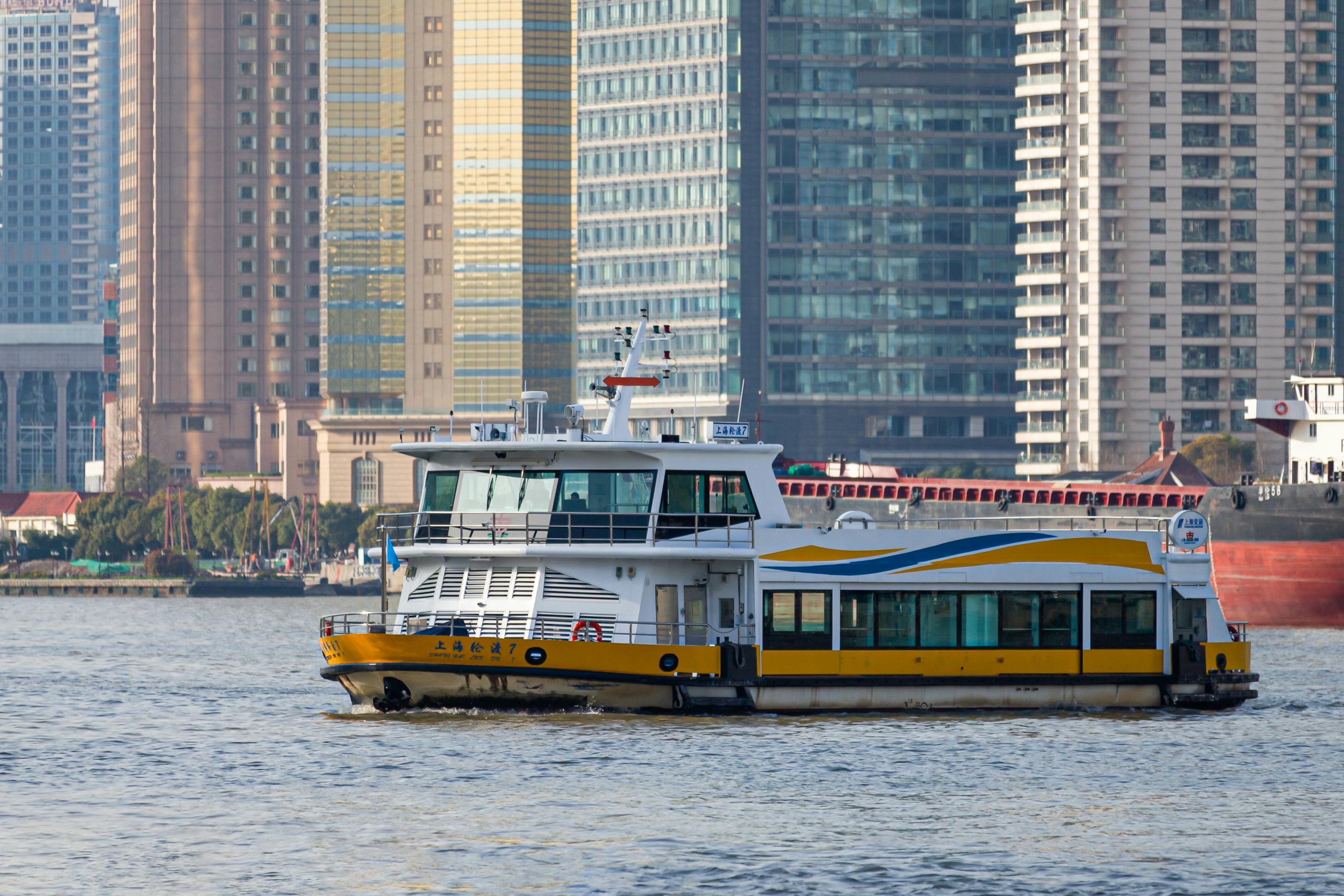 Modern Ferry on Urban Waterway at Daytime · Free Stock Photo