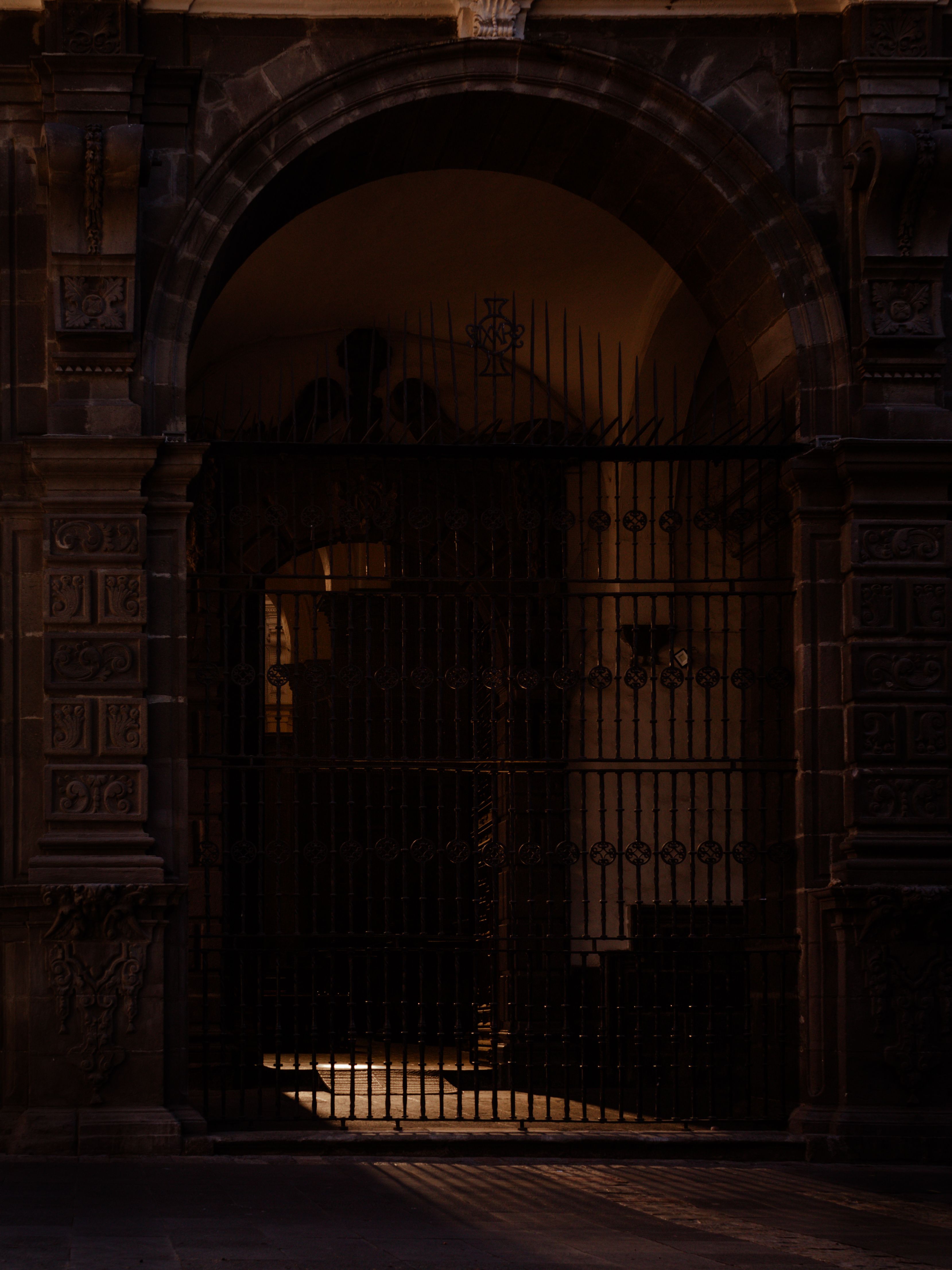 Gothic Iron Gate at Historic Stone Archway · Free Stock Photo
