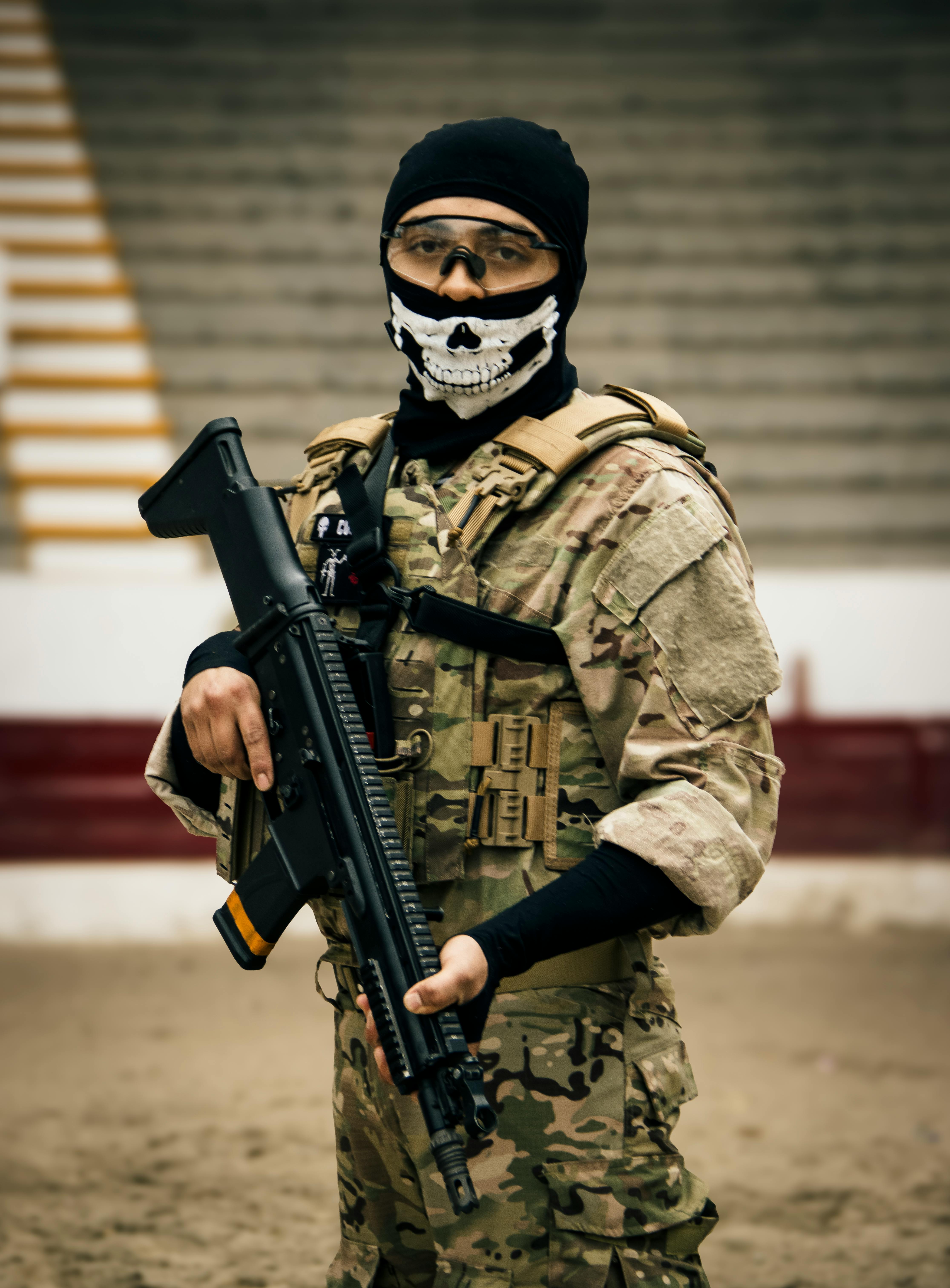 Camouflaged Soldier with Tactical Gear and Rifle · Free Stock Photo