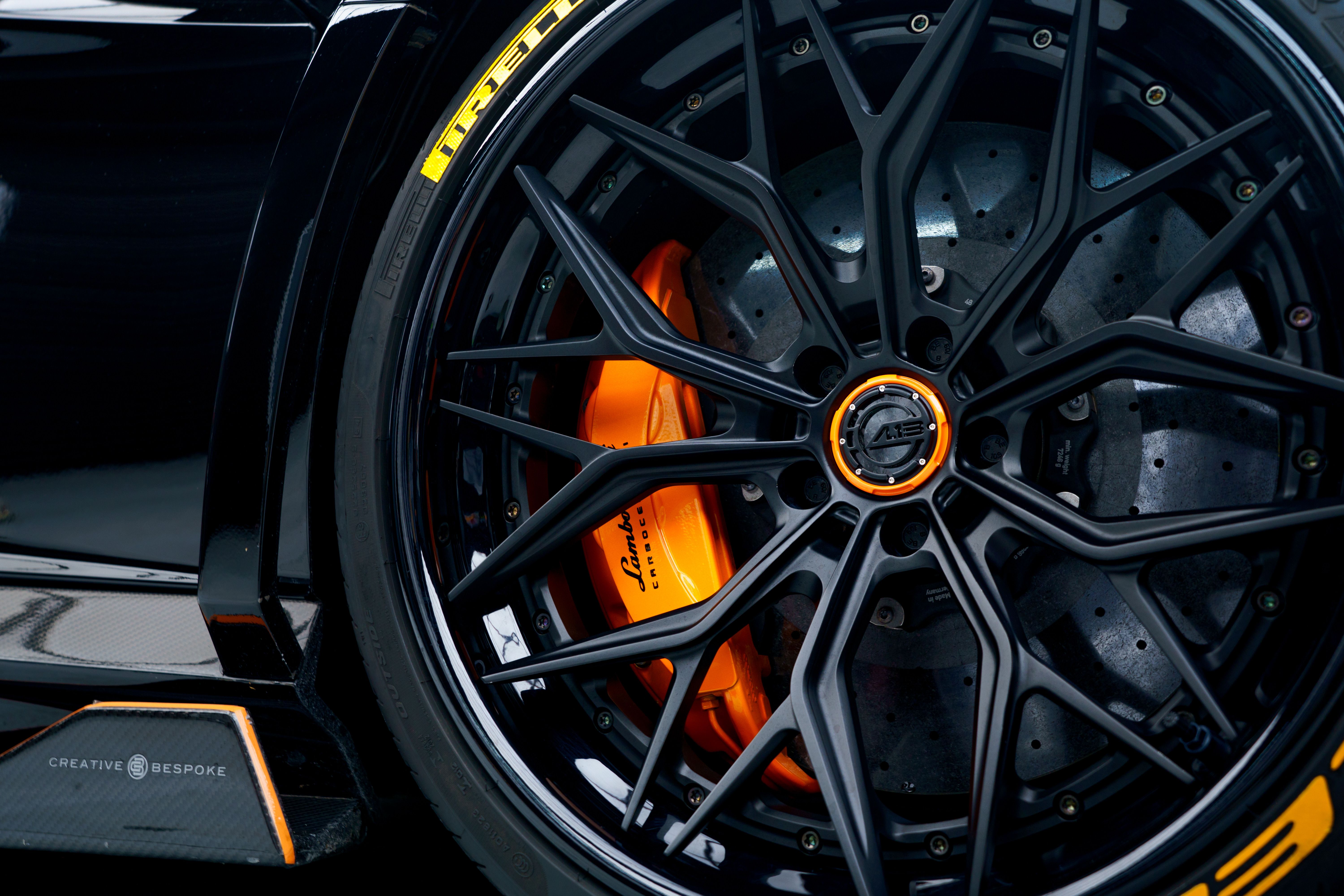 Close-up of Sportscar Wheel with Orange Brake Caliper · Free Stock Photo