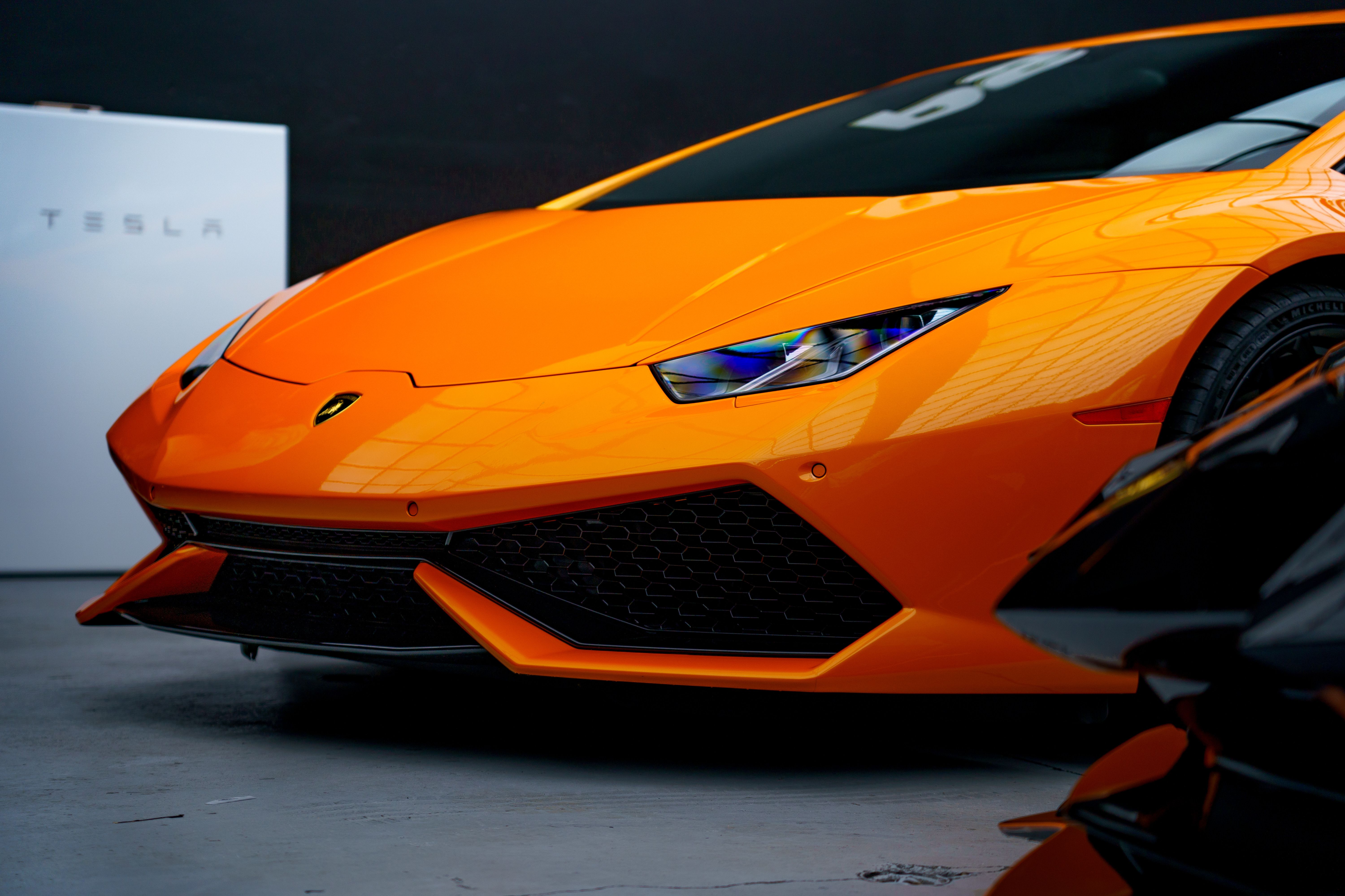 Vibrant Orange Sports Car Front View Close-Up · Free Stock Photo