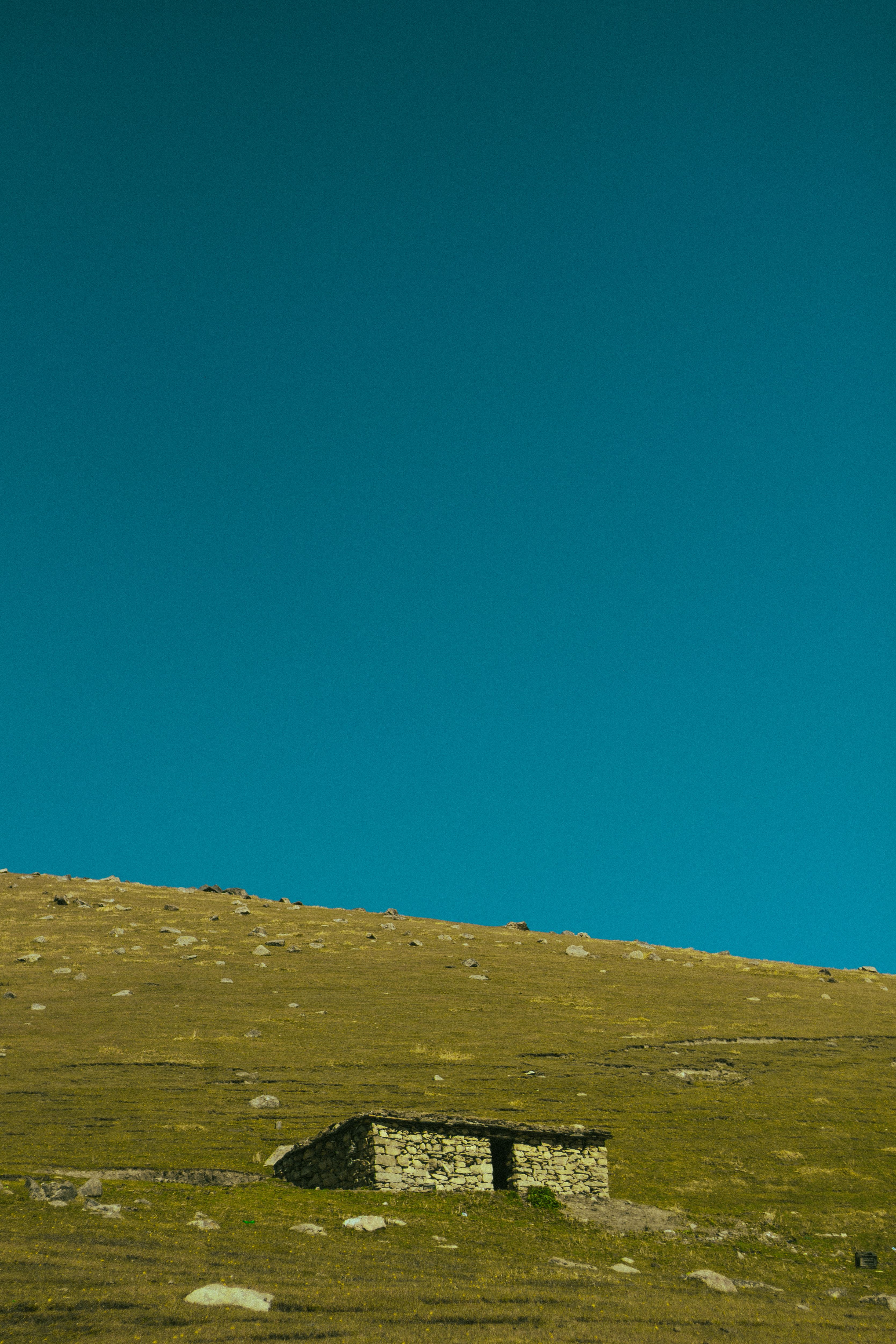 Isolated Stone Hut on Vast Green Hill · Free Stock Photo