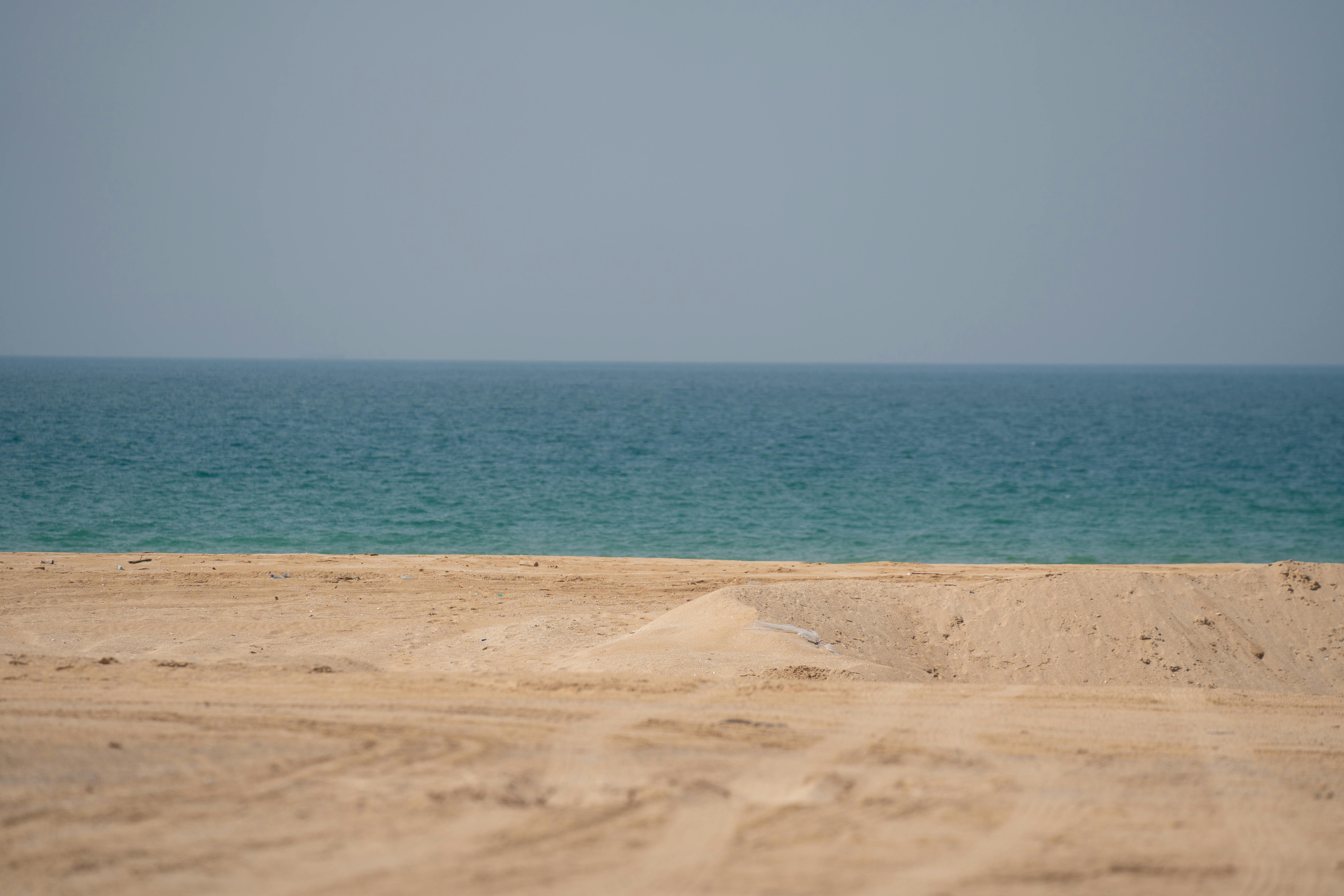 Serene Beachfront with Golden Sand and Blue Sea · Free Stock Photo