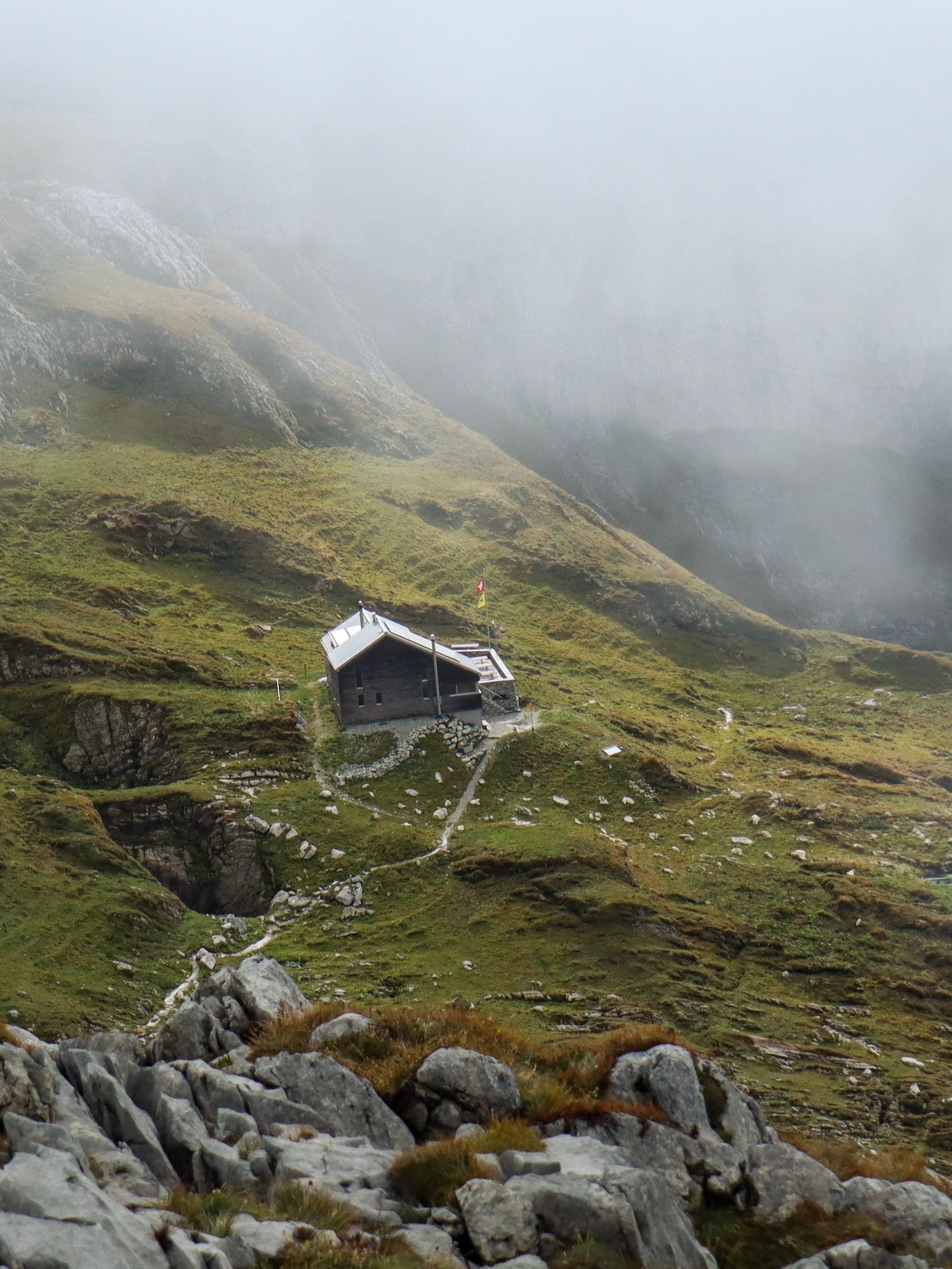 Misty Alpine Mountain Hut in Swiss Alps · Free Stock Photo