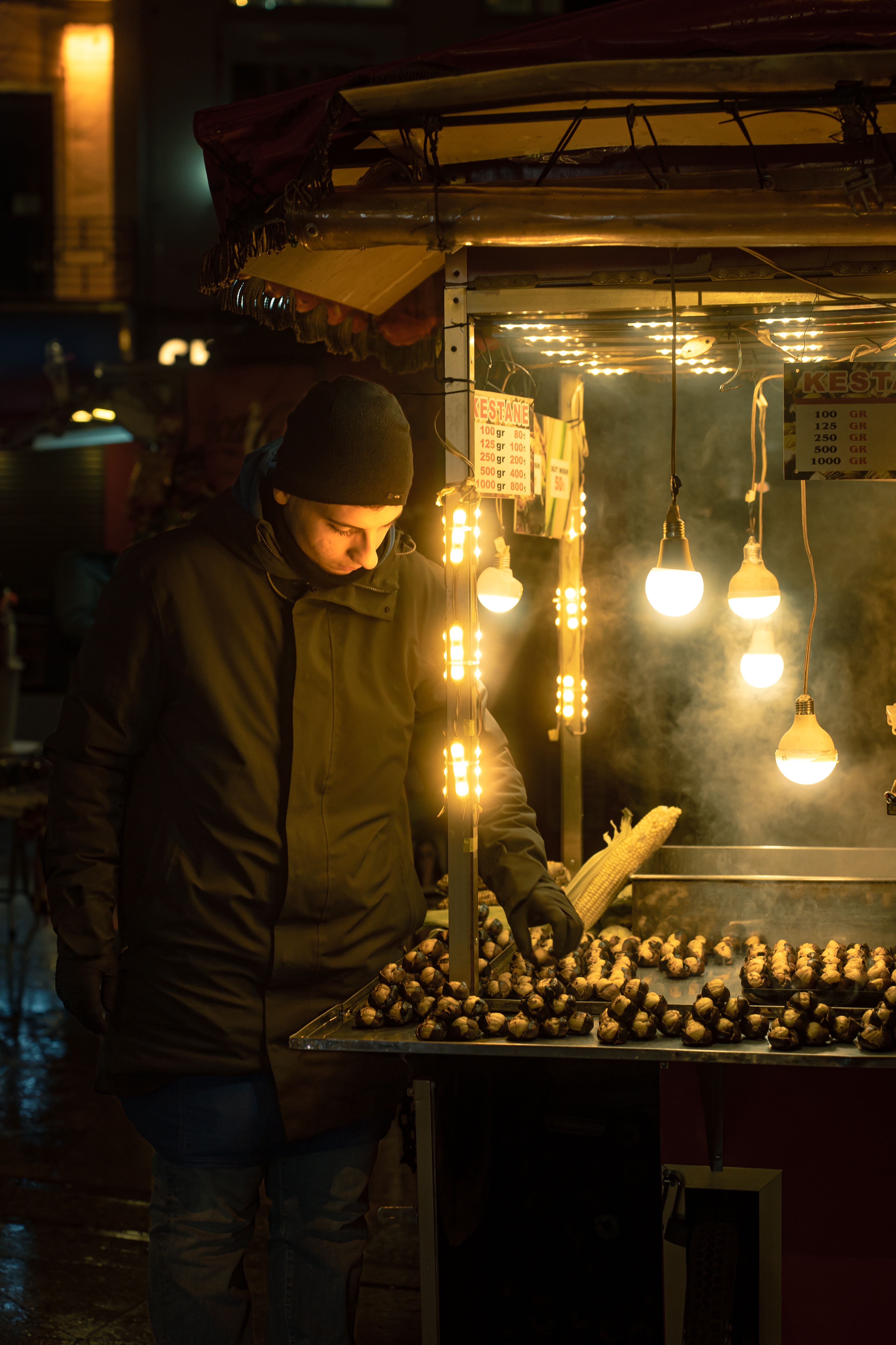 Man at Night Street Food Market Gazing at Roasted Chestnuts · Free ...