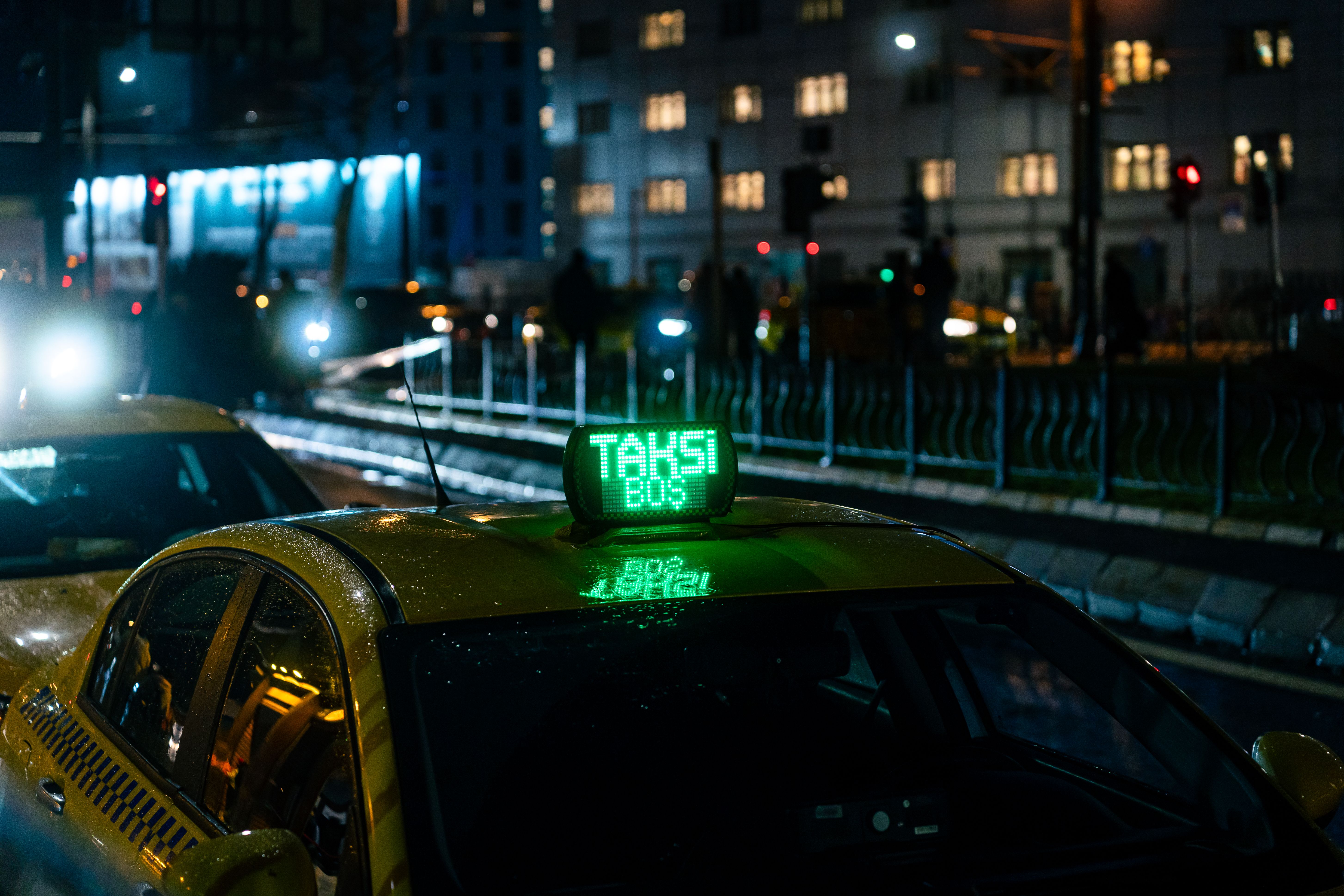 Nighttime City Taxi with Illuminated Sign · Free Stock Photo