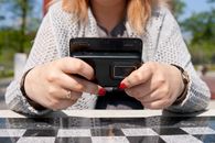 Close up portrait of a young woman typing a text message on mobile ...