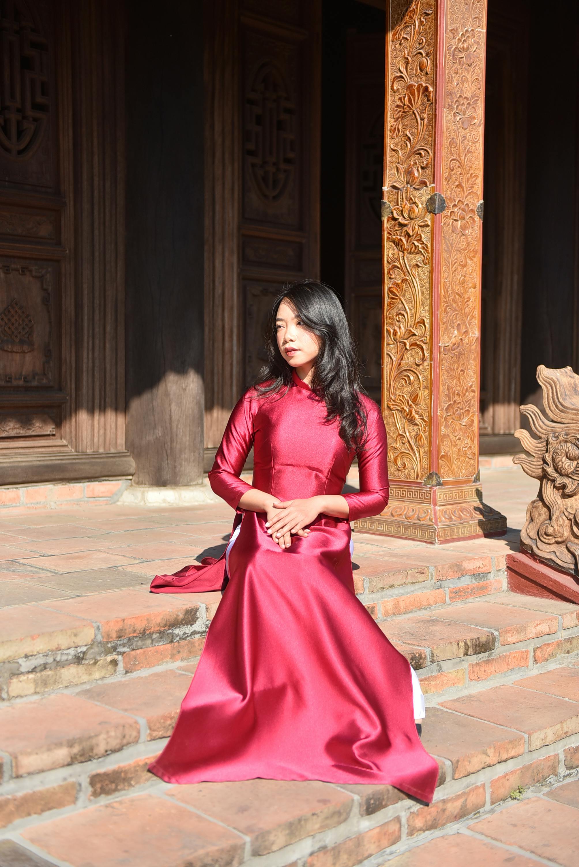 Woman in Traditional Dress on Stone Steps · Free Stock Photo