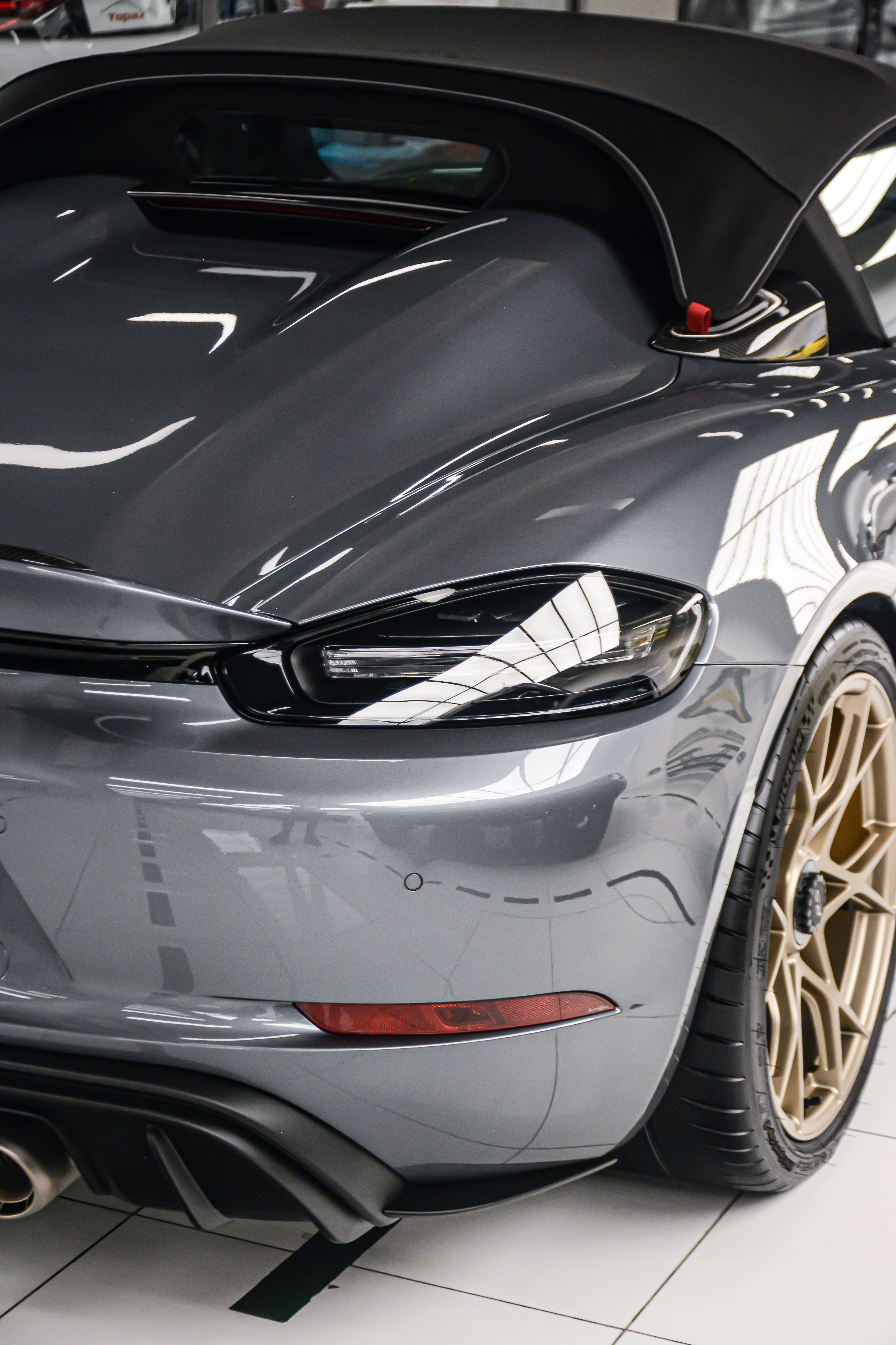 Sleek Grey Sports Car in Showroom Setting · Free Stock Photo