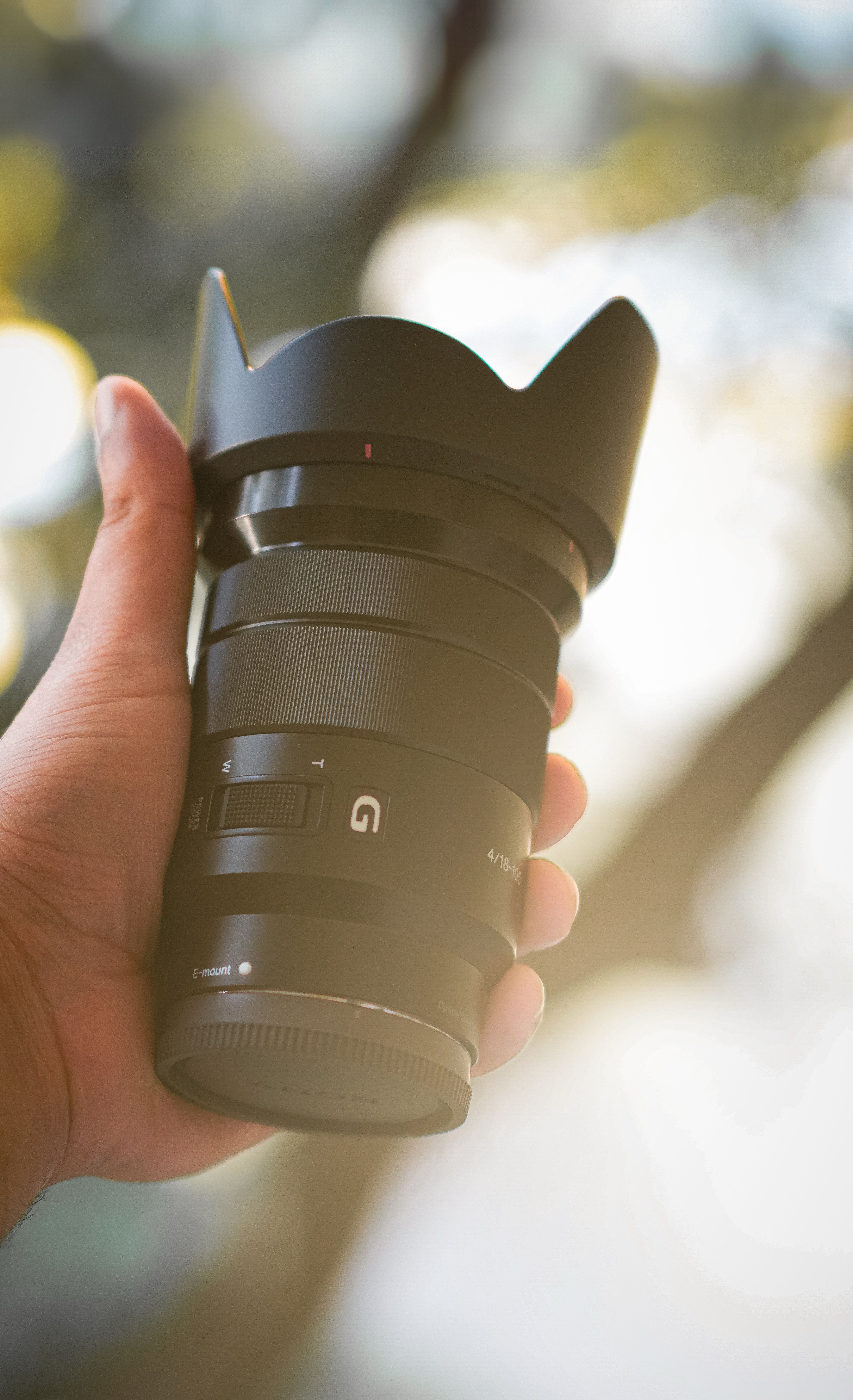 Close-up of a Camera Lens Held Outdoors · Free Stock Photo