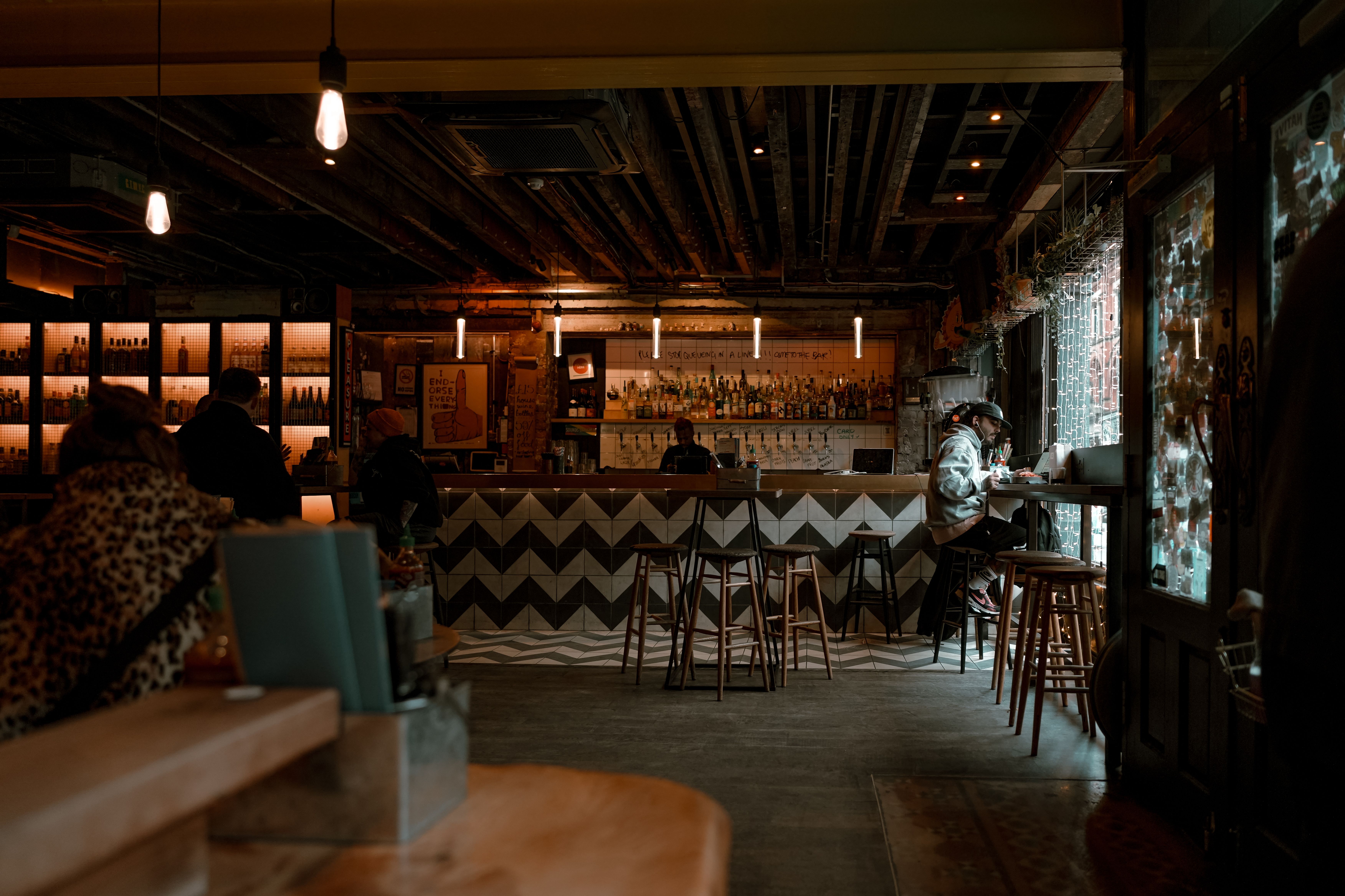 Cozy Urban Bar Interior with Warm Lighting · Free Stock Photo
