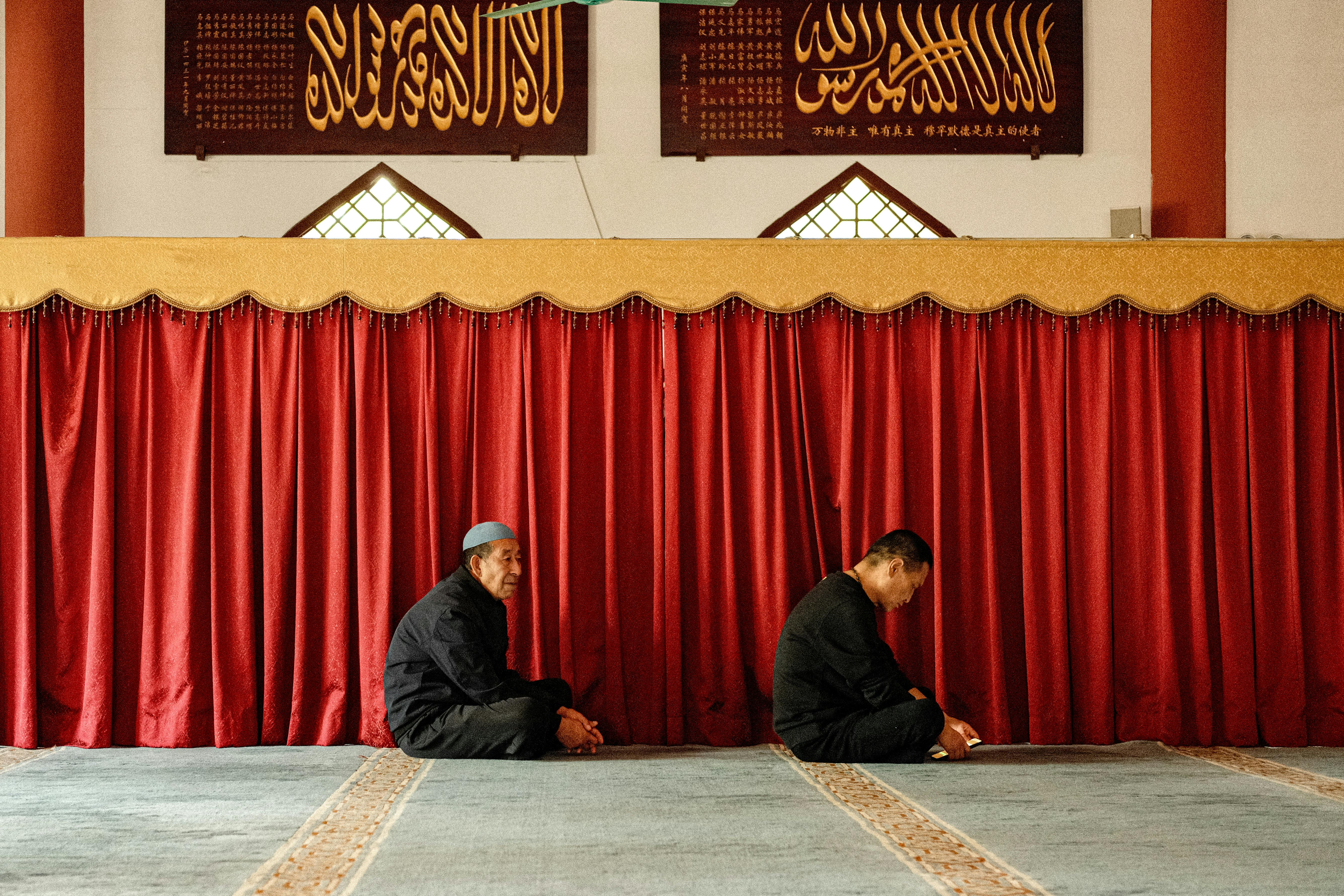 Two Men Praying in a Mosque with Red Curtains · Free Stock Photo