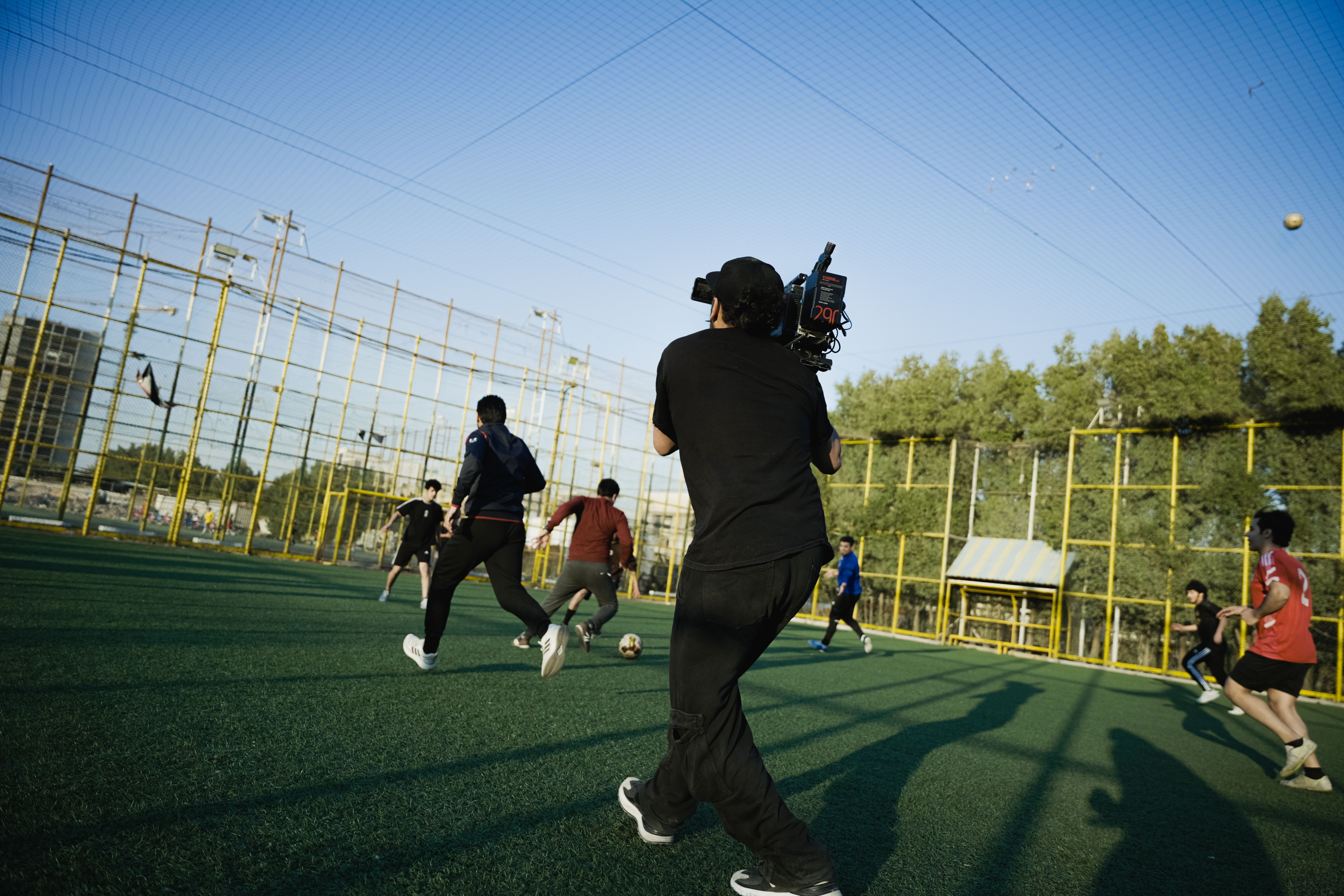 Action-Packed Outdoor Soccer Game with Filmmaker · Free Stock Photo