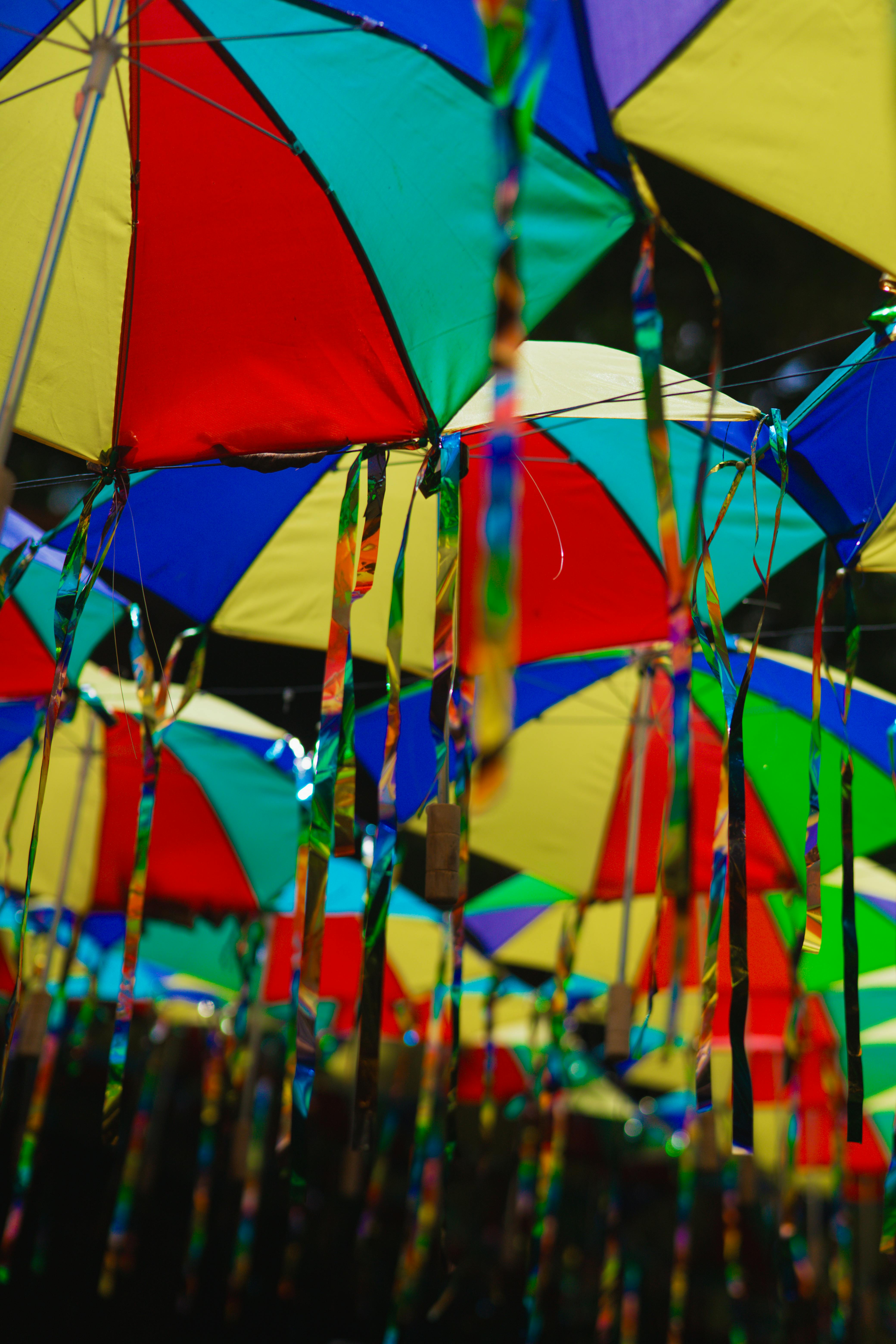 Colorful Kite Display with Vibrant Patterns · Free Stock Photo