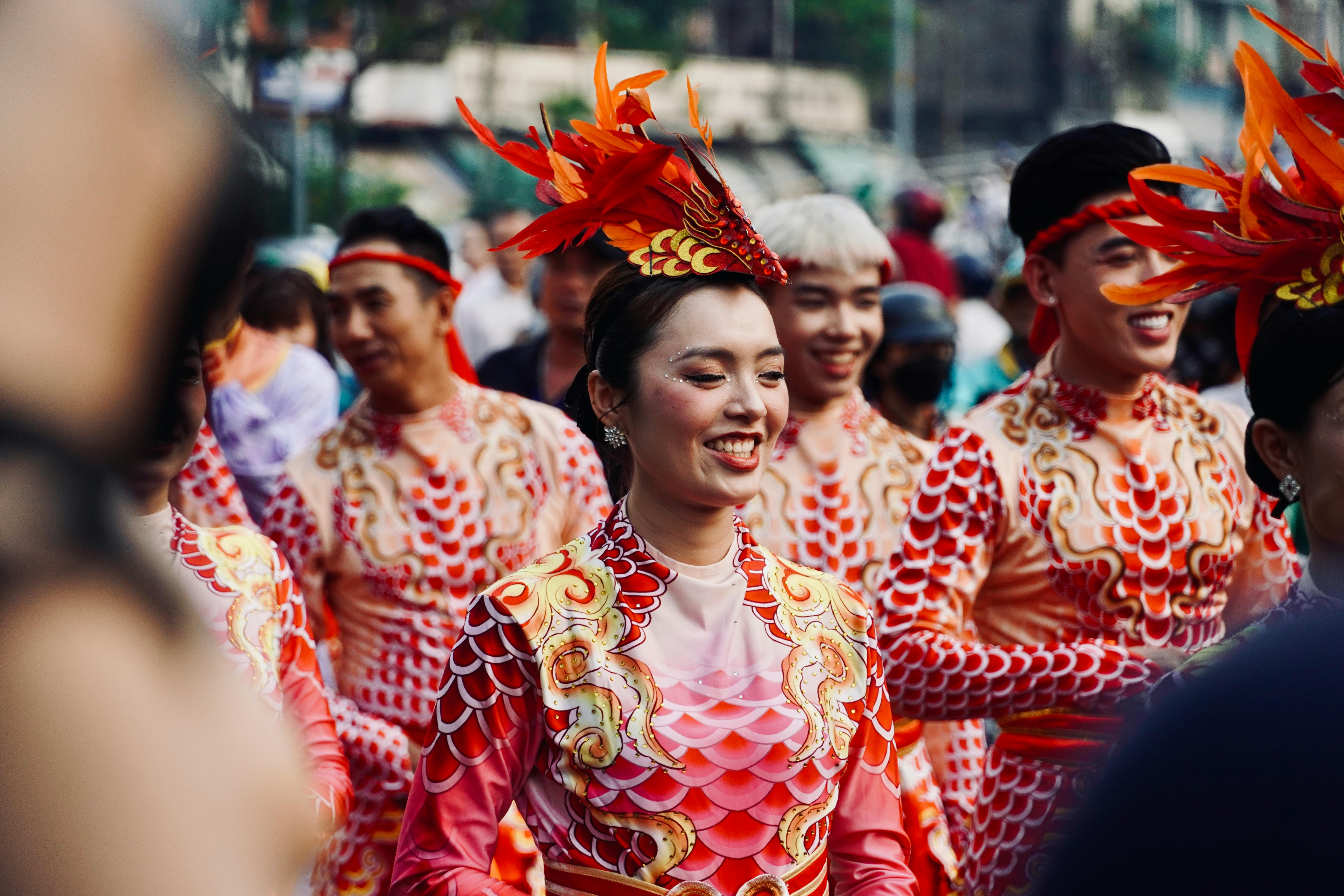 Colorful Parade with Smiling Performers in Traditional Attire · Free ...
