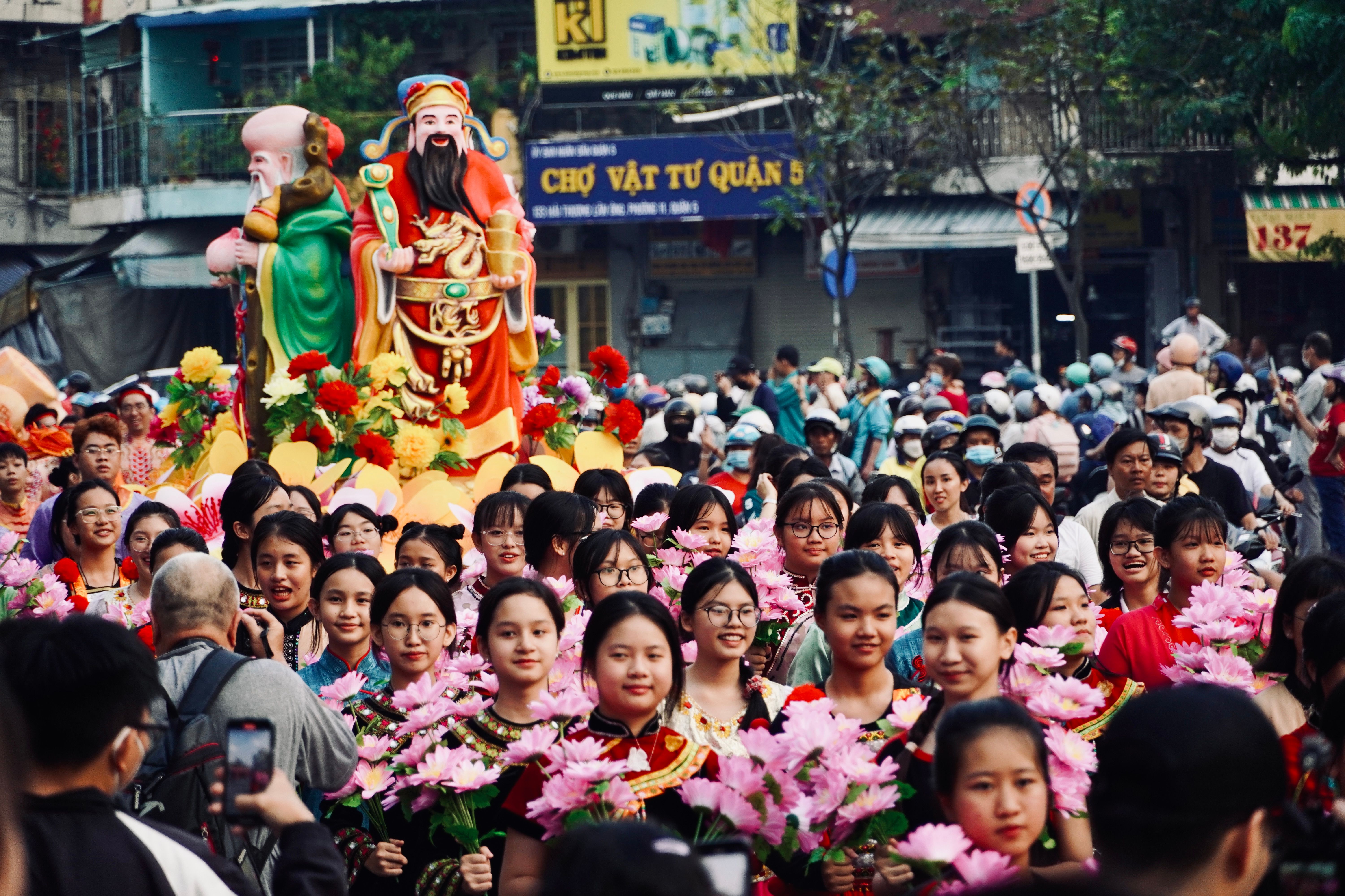Colorful Asian Festival Parade with Floral Decorations · Free Stock Photo