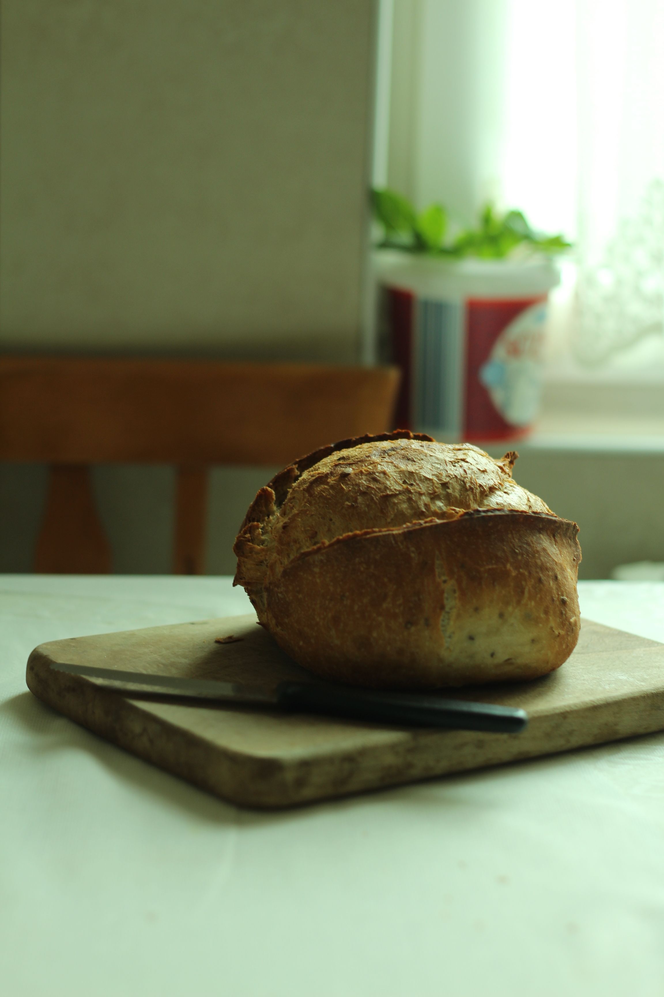 Rustic Loaf of Bread on Kitchen Table · Free Stock Photo
