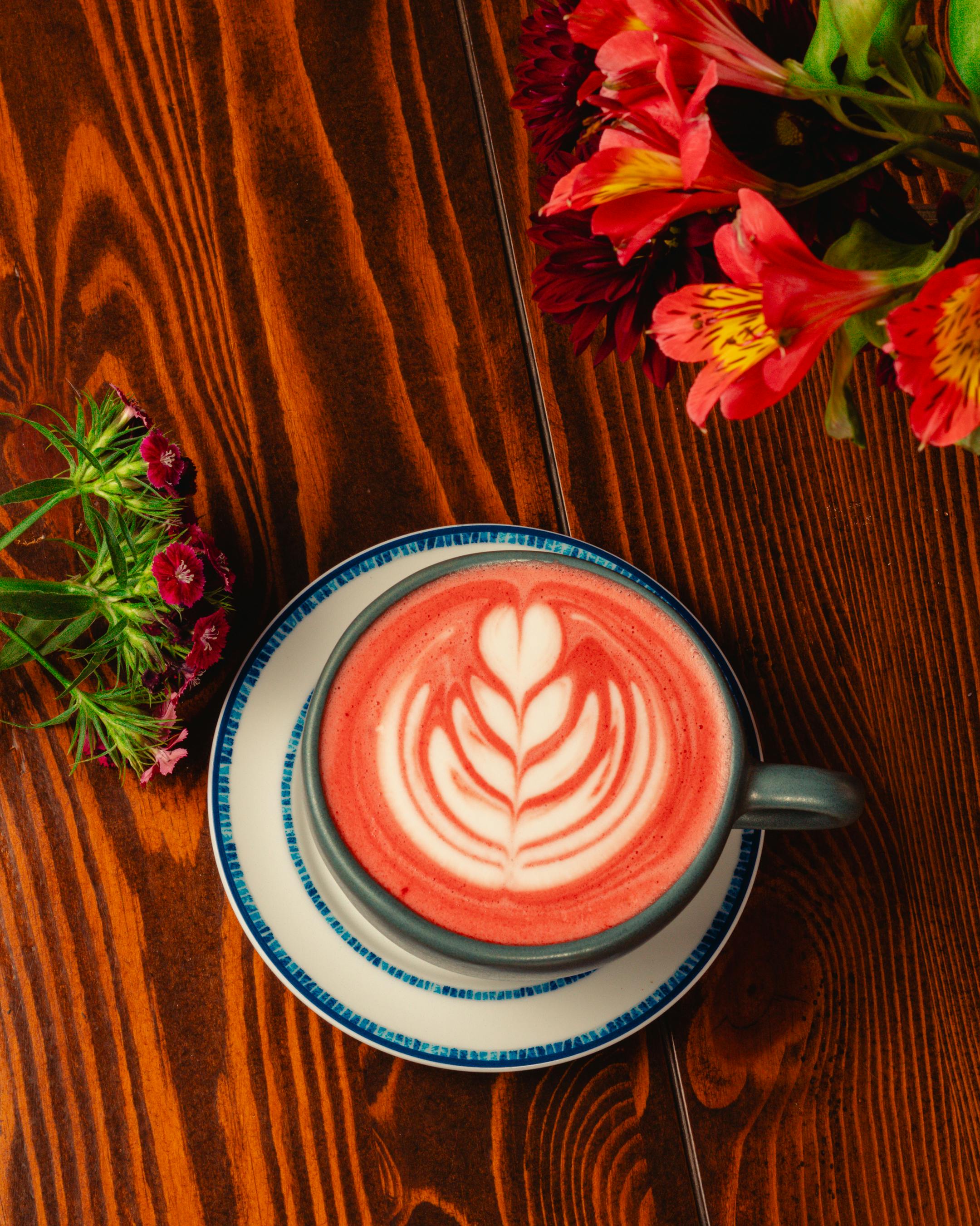 Top View of Red Latte with Floral Arrangement · Free Stock Photo