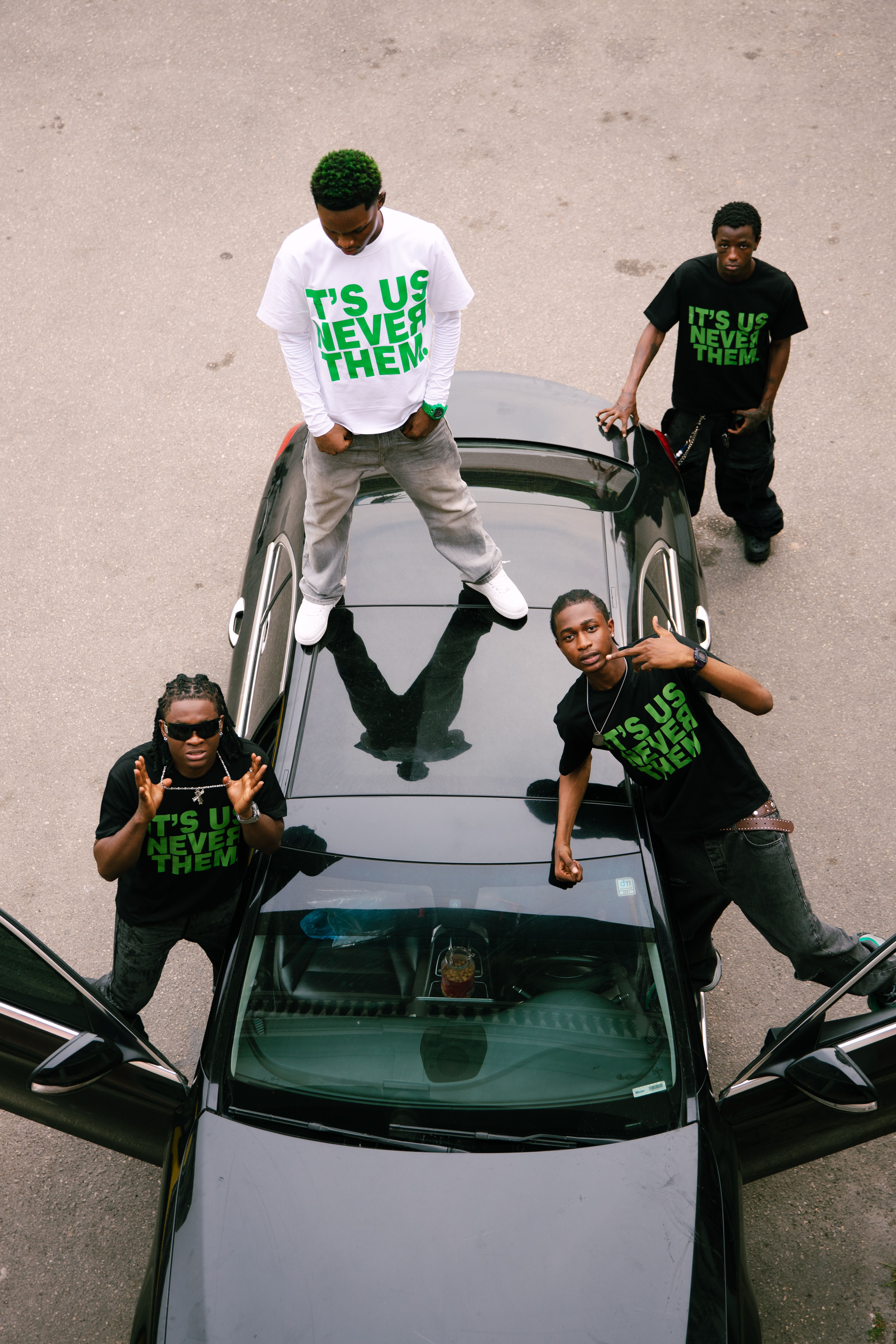 Group of Friends Posing on a Car in Urban Setting · Free Stock Photo
