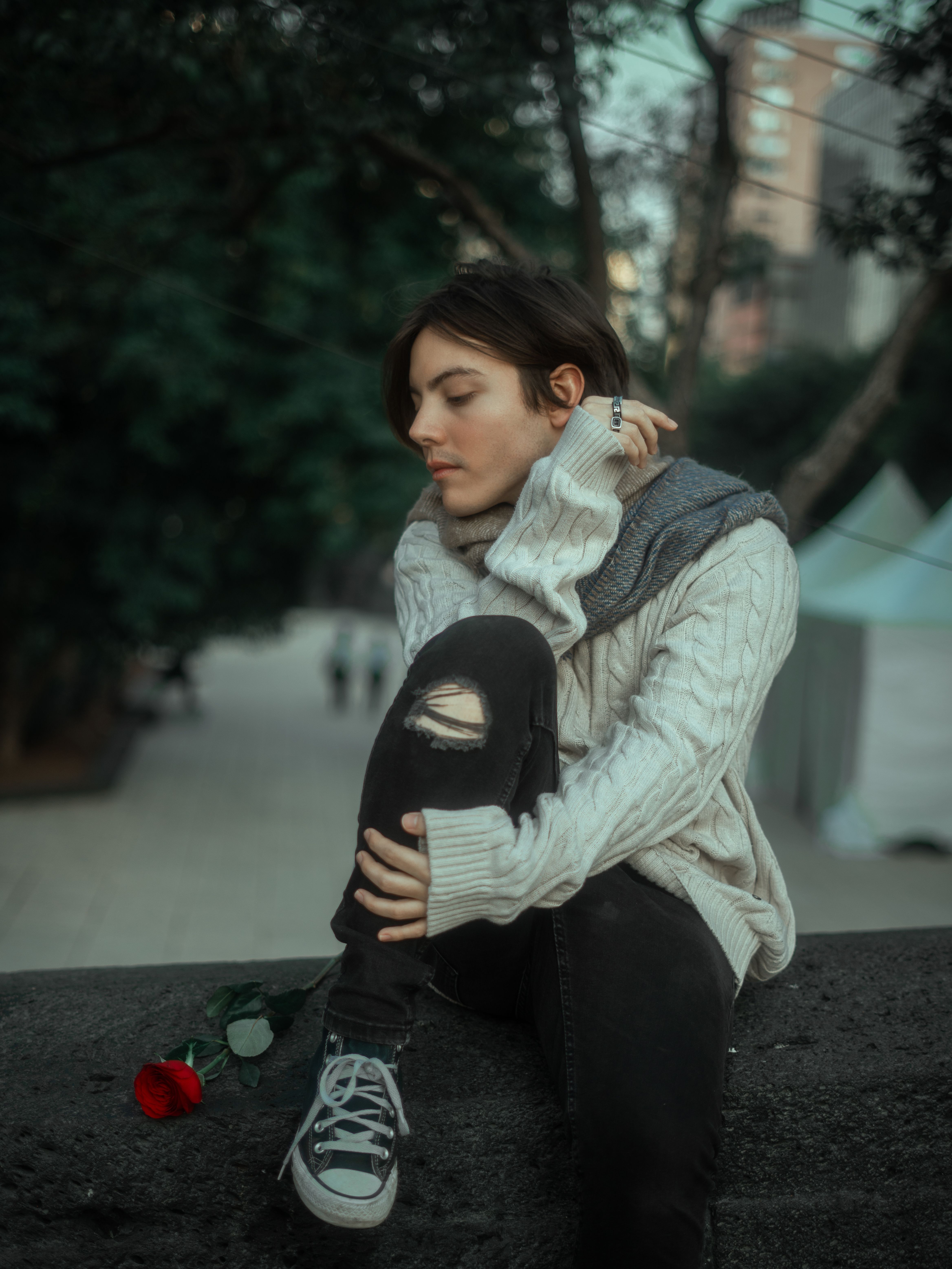Pensive Woman with Rose in Urban Setting · Free Stock Photo
