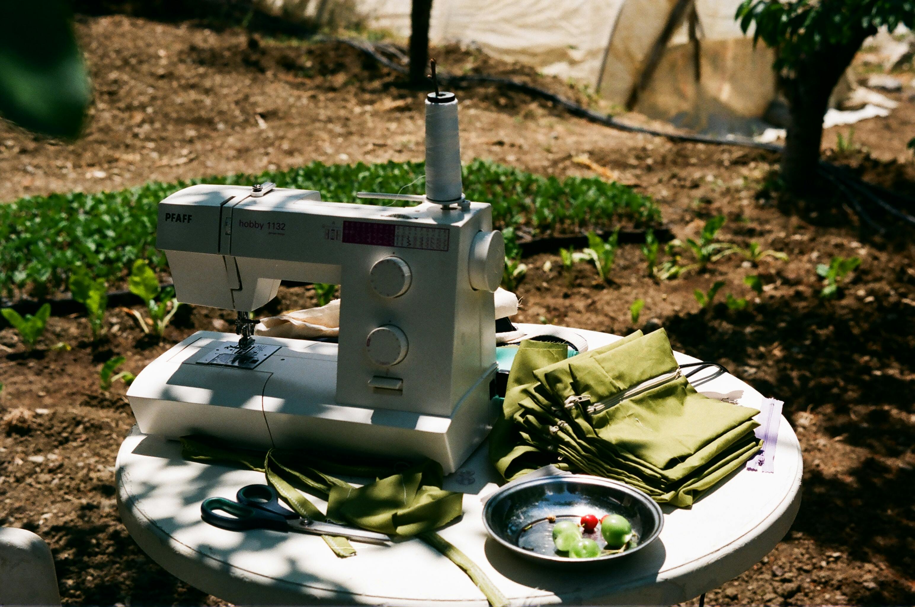 Outdoor sewing station with garden backdrop · Free Stock Photo