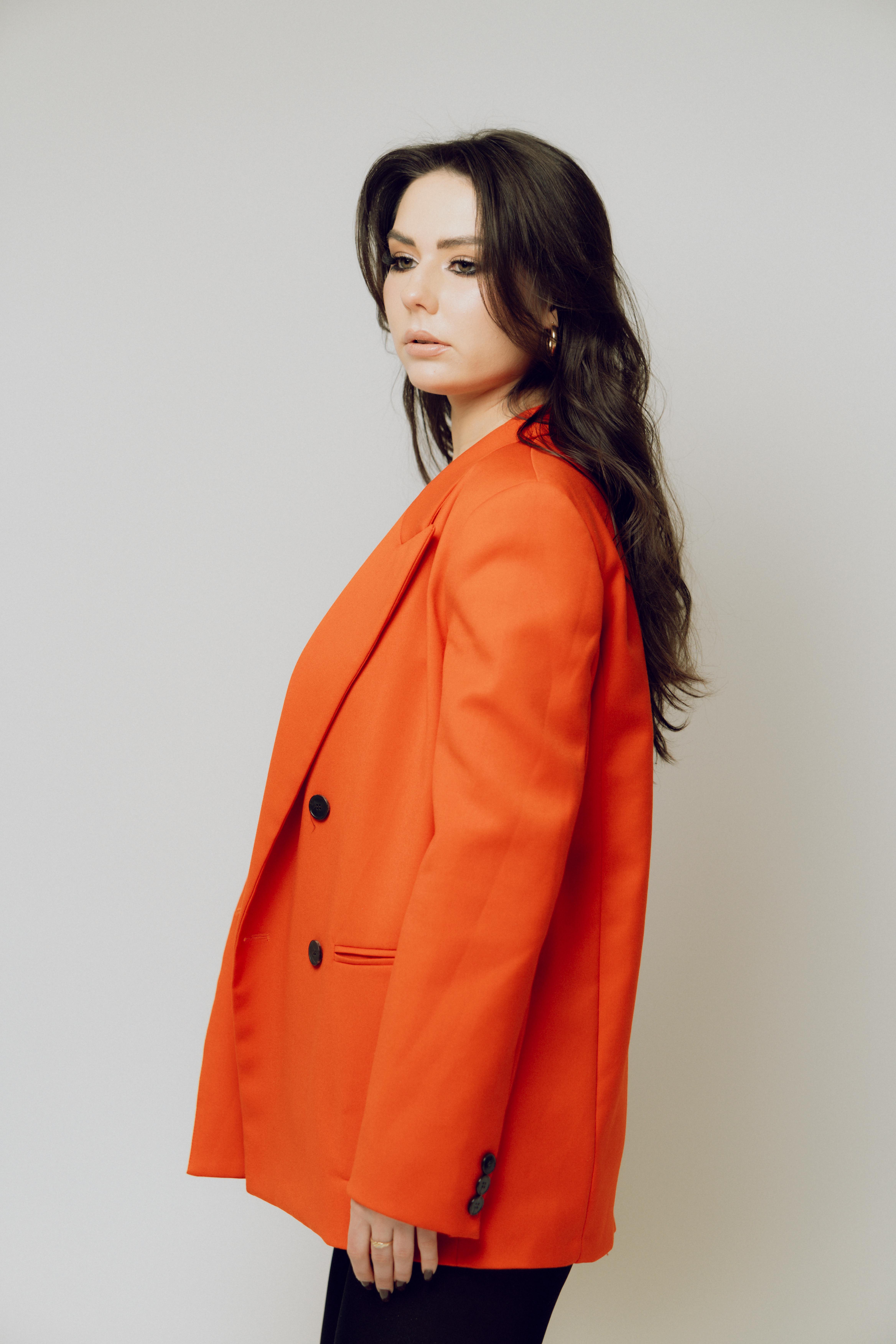 Stylish Woman in Vibrant Red Jacket Portrait · Free Stock Photo
