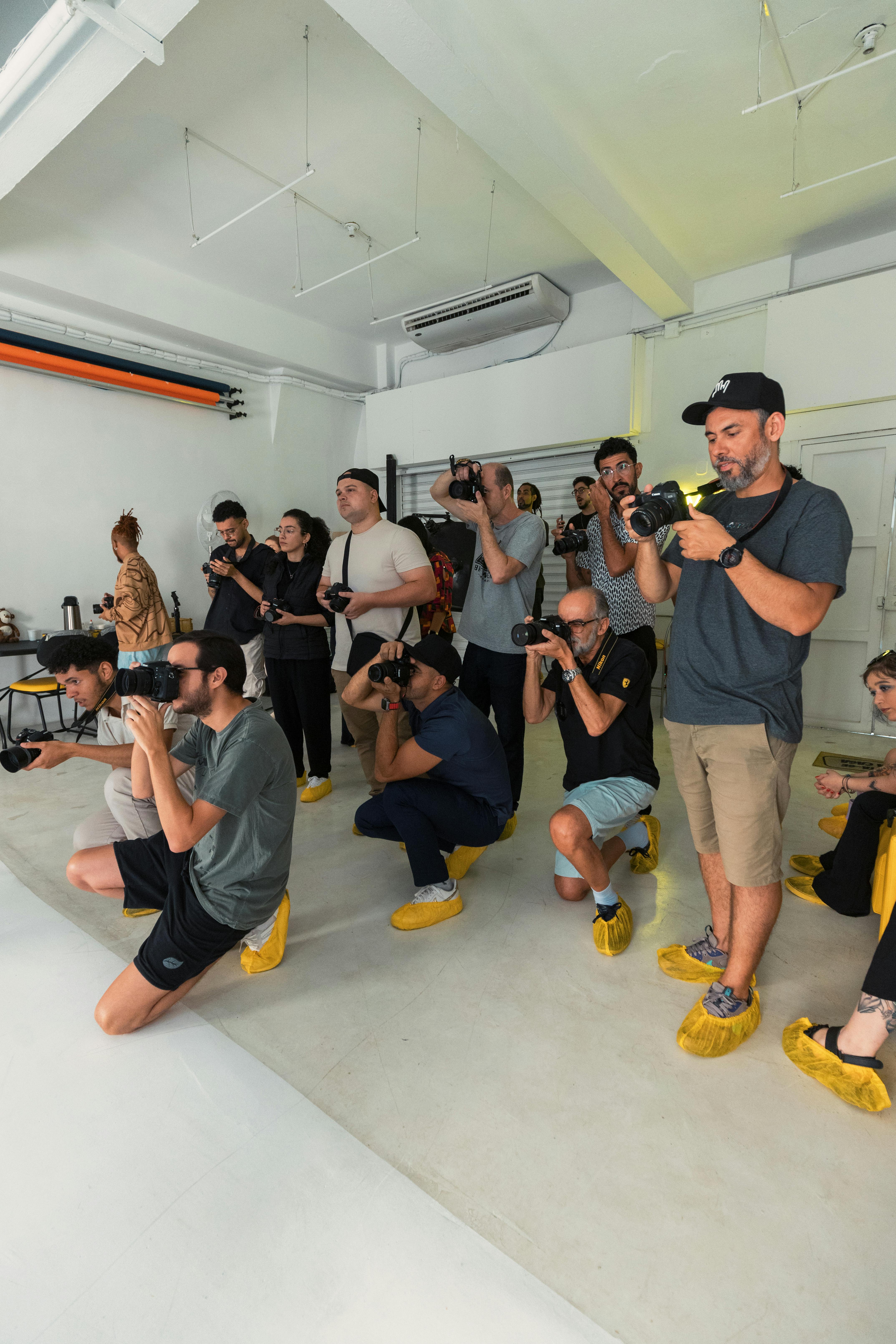 Group of Photographers in a Studio Setting · Free Stock Photo