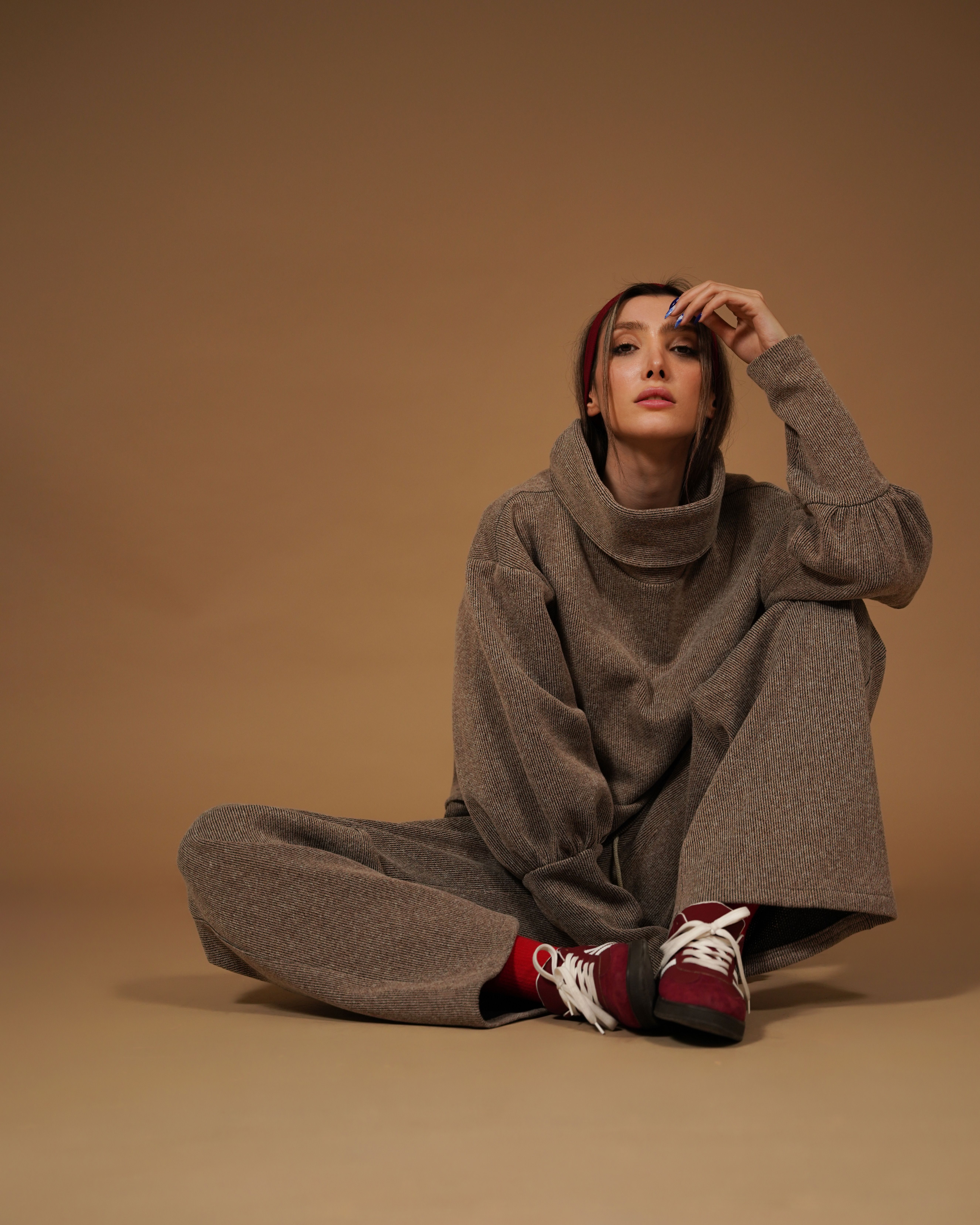Stylish Woman in Neutral Outfit Sitting Pose · Free Stock Photo