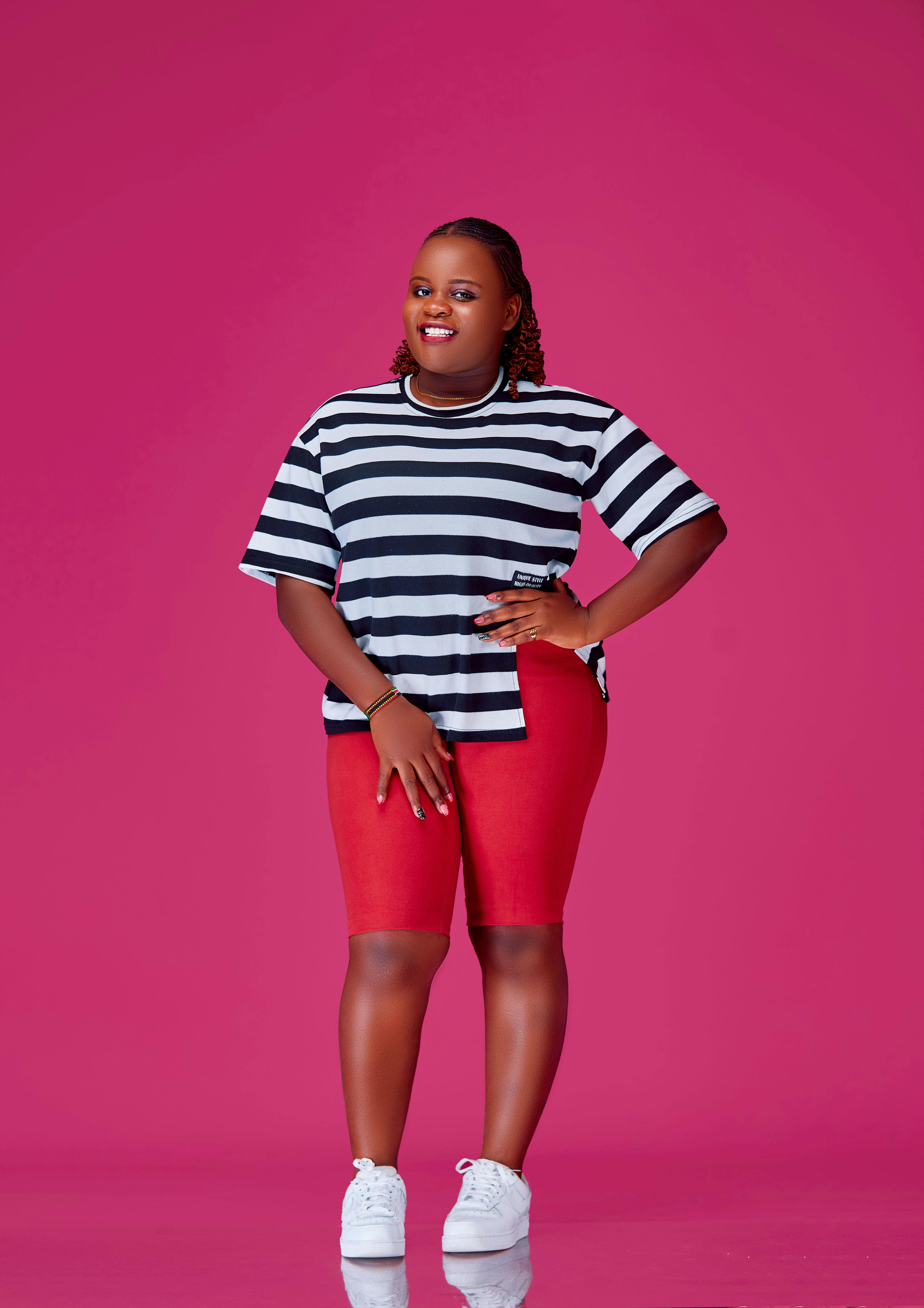 Woman in Striped Shirt Against Pink Background · Free Stock Photo