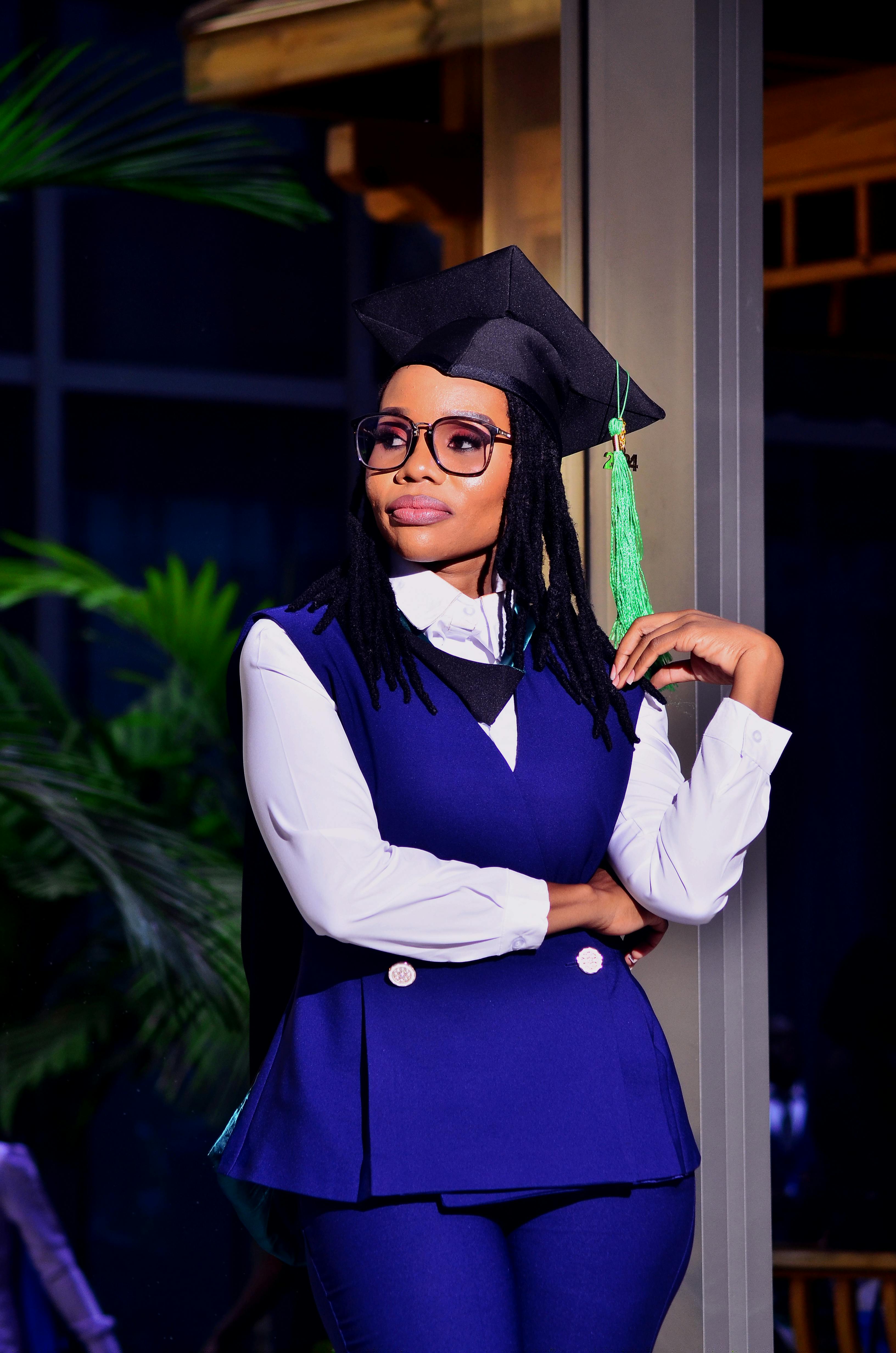 Confident Graduate Posing in Academic Attire · Free Stock Photo