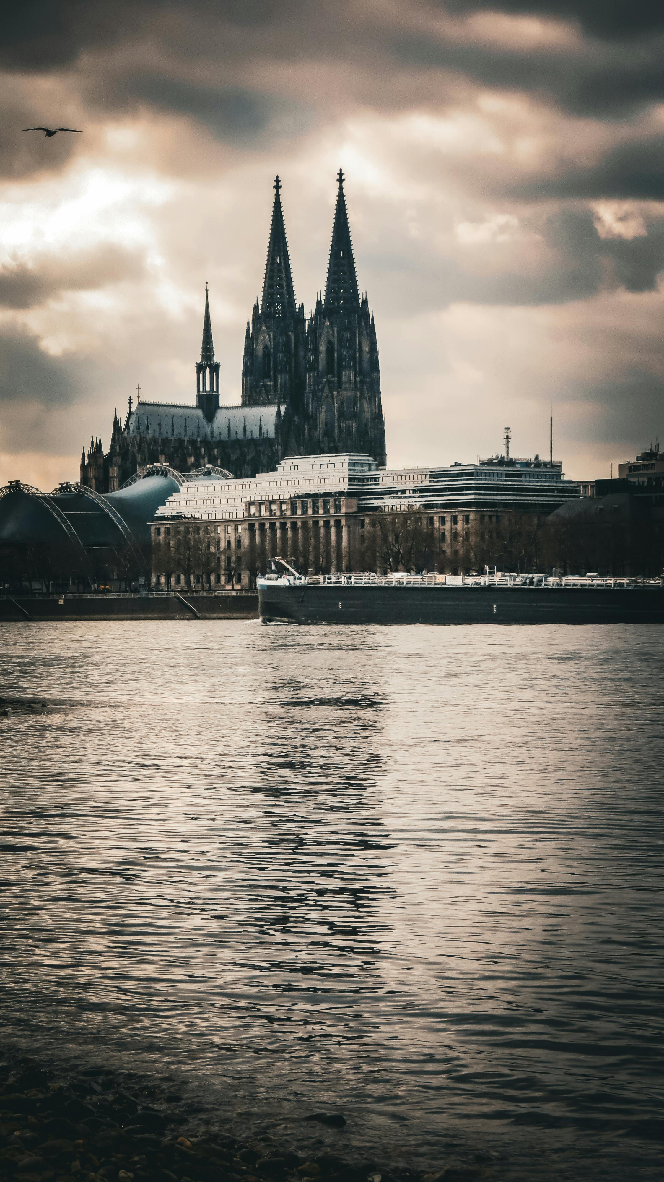 Cologne Cathedral with Rhine River in Foreground · Free Stock Photo