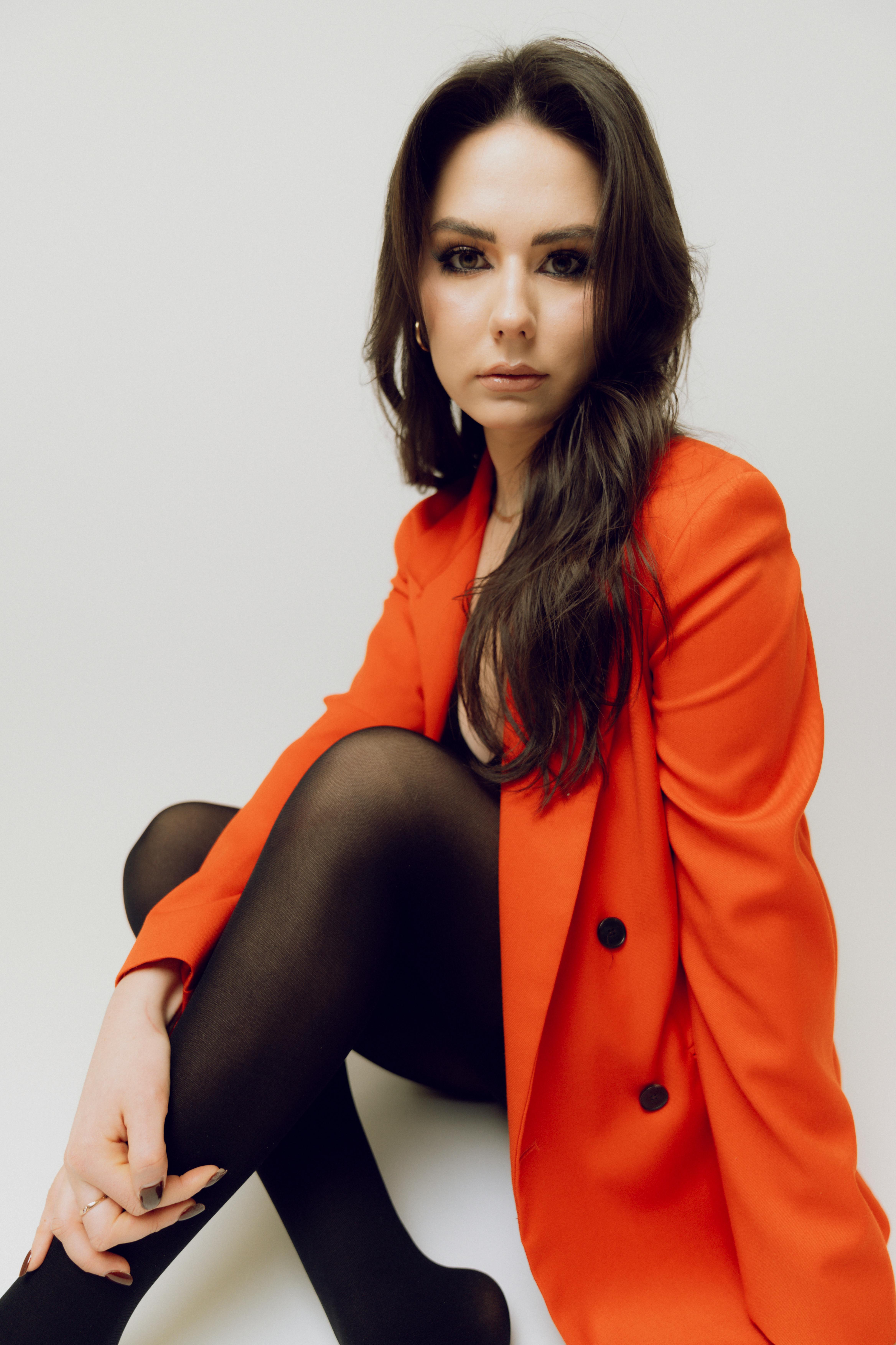 Elegant Fashion Model Posing in a Red Jacket · Free Stock Photo