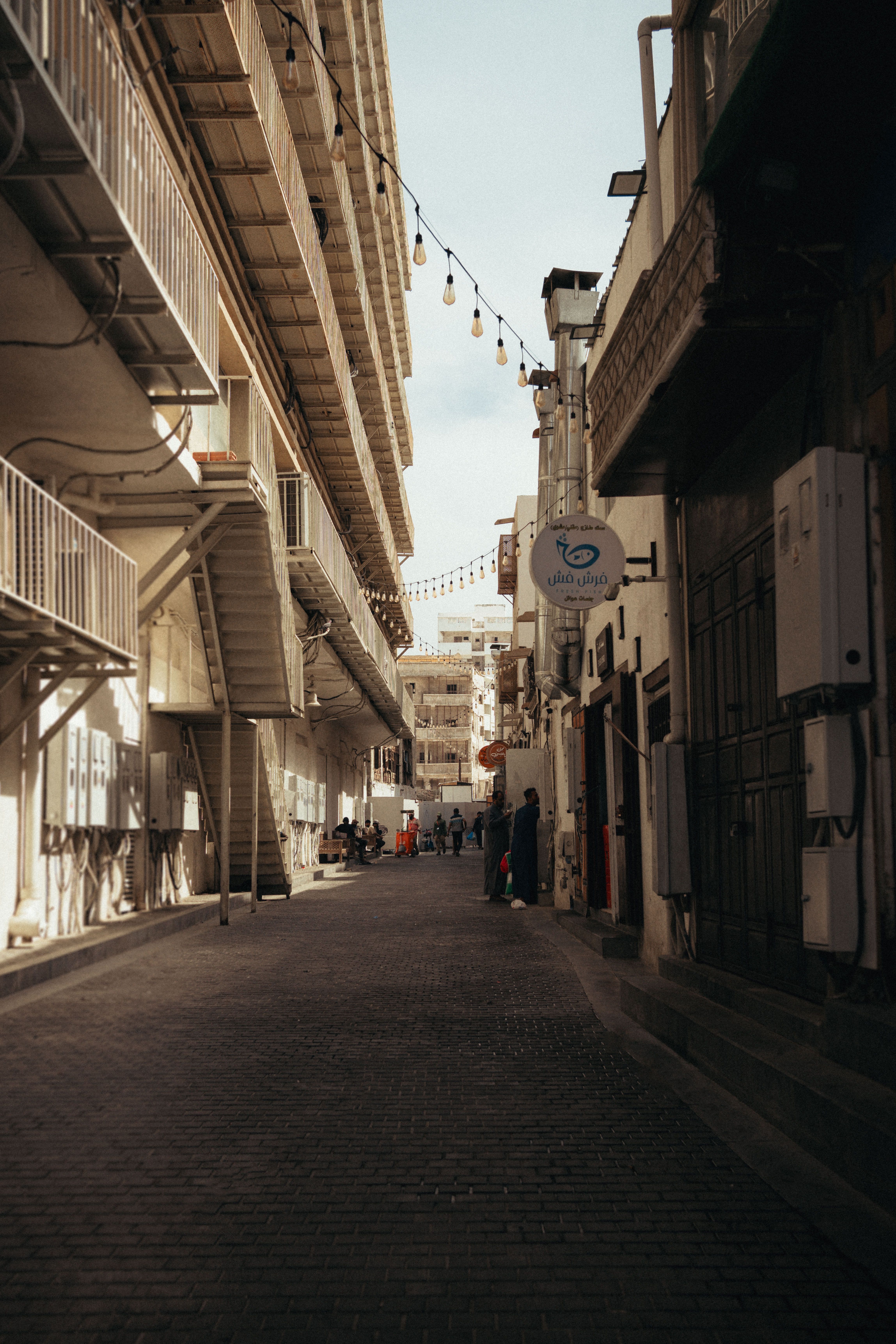 Narrow Middle Eastern Street with Multi-Story Buildings · Free Stock Photo