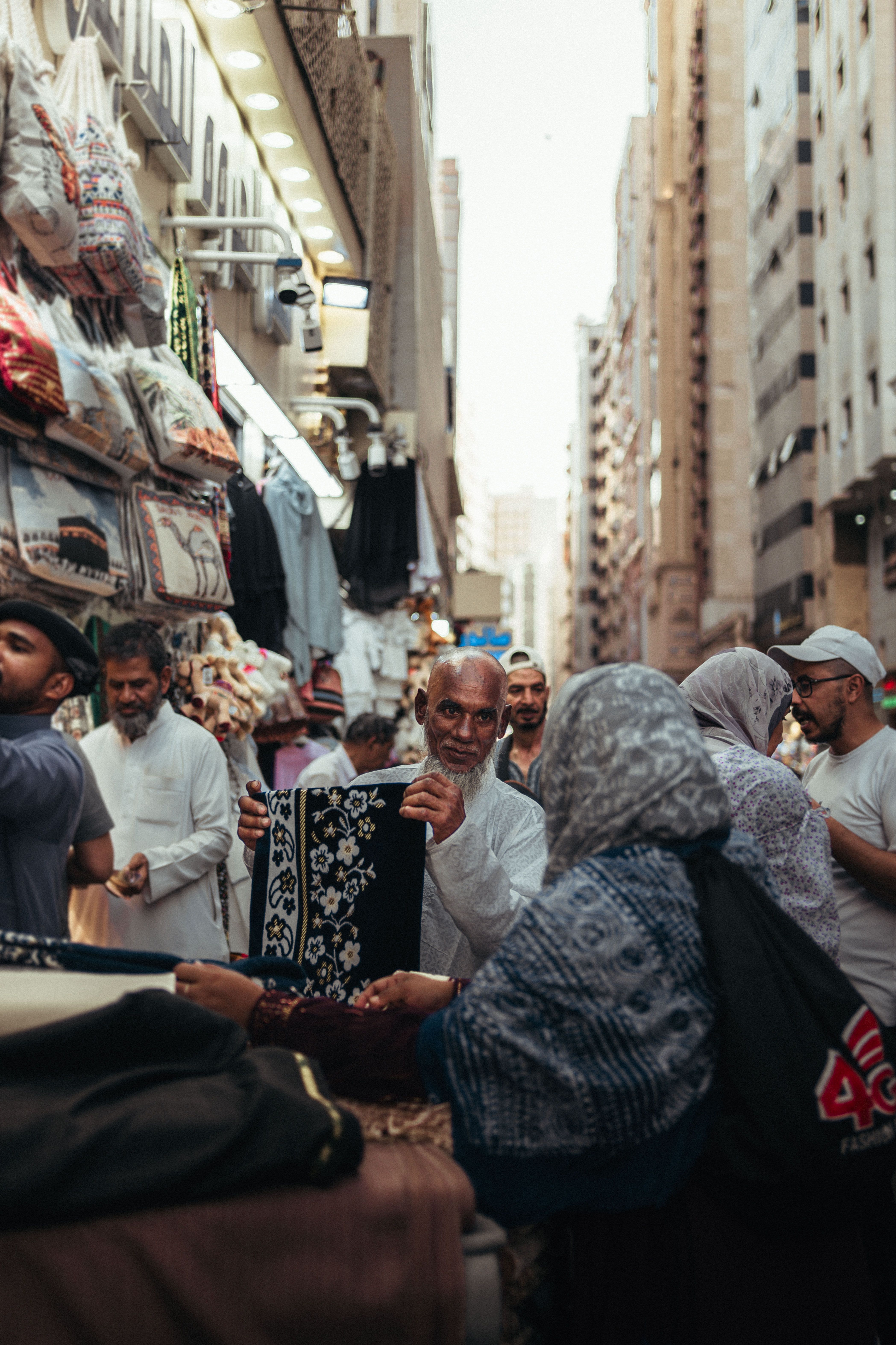 Bustling Market Scene with Textile Merchant · Free Stock Photo