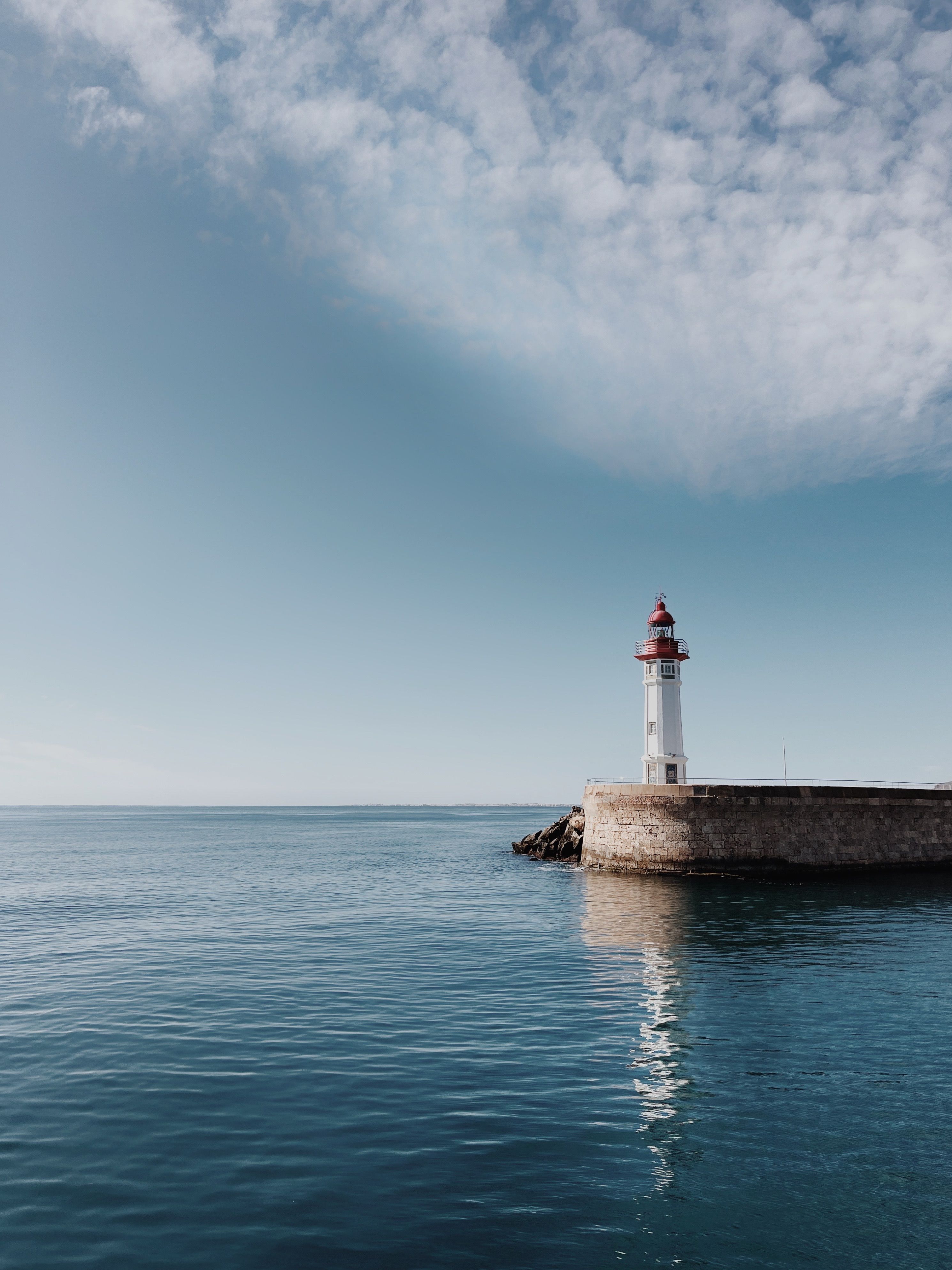 Serene Lighthouse Overlooking Calm Ocean Waters · Free Stock Photo