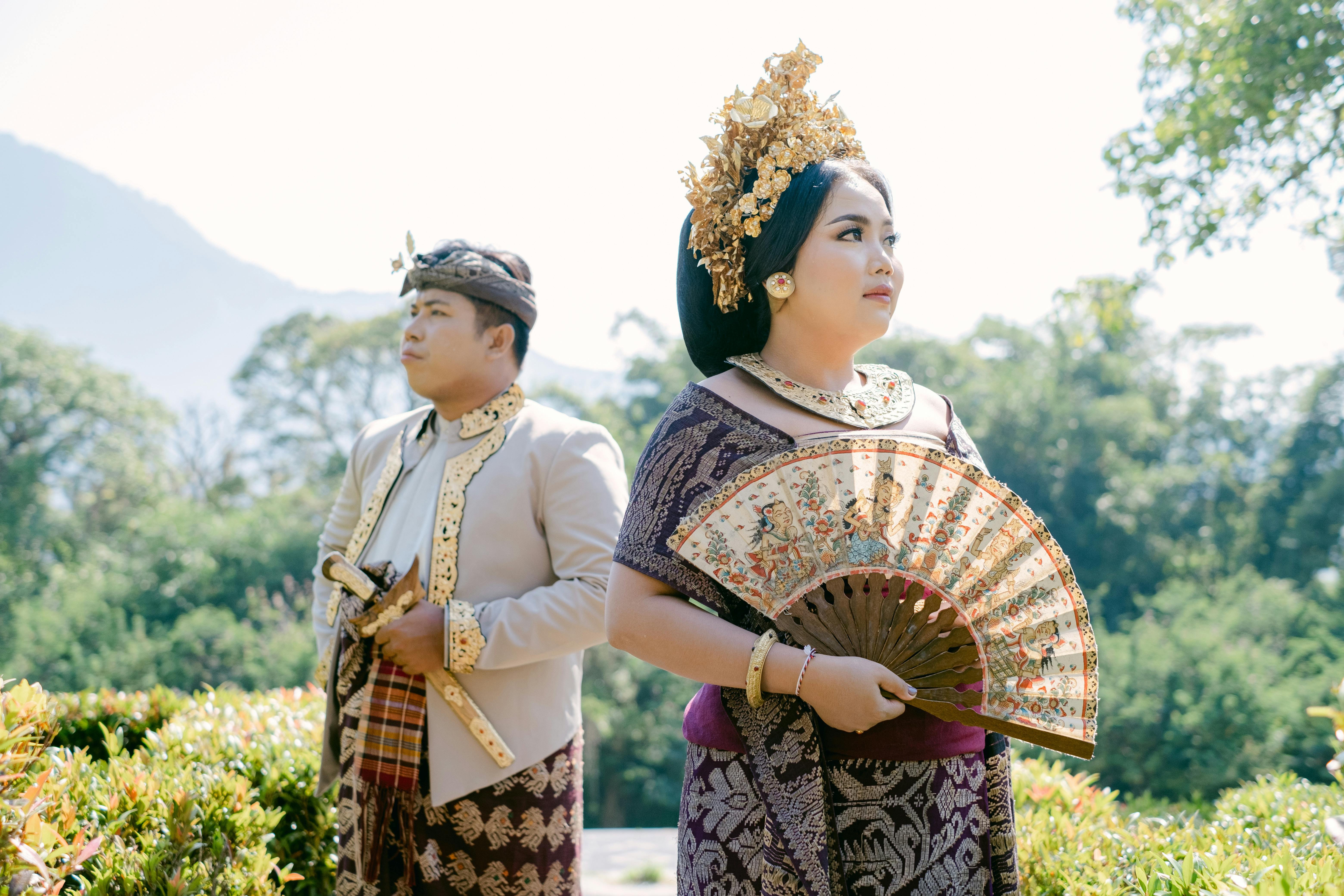 Traditional Balinese Wedding Attire in Scenic Landscape · Free Stock Photo