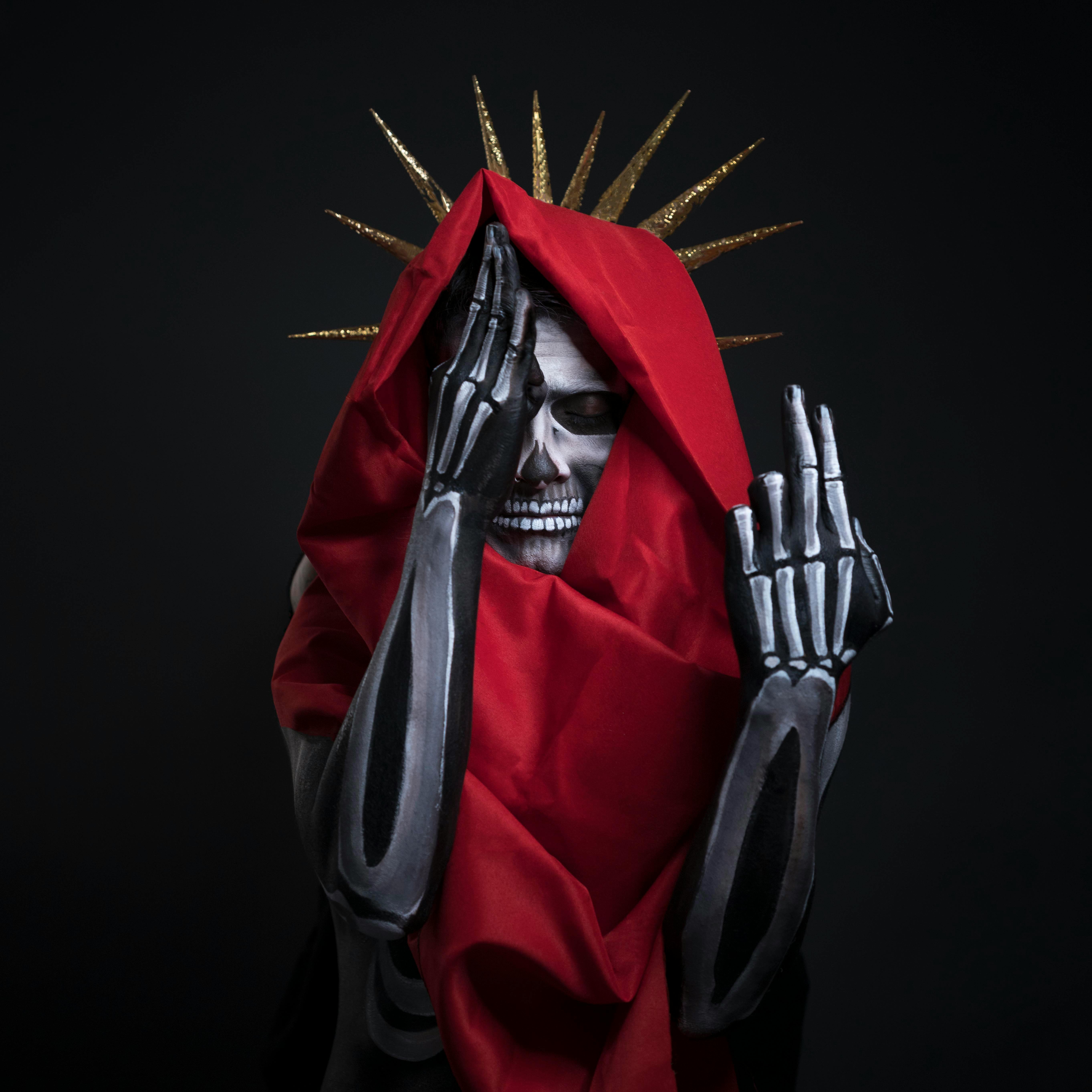 Skeleton Costume with Red Cloth and Golden Halo · Free Stock Photo