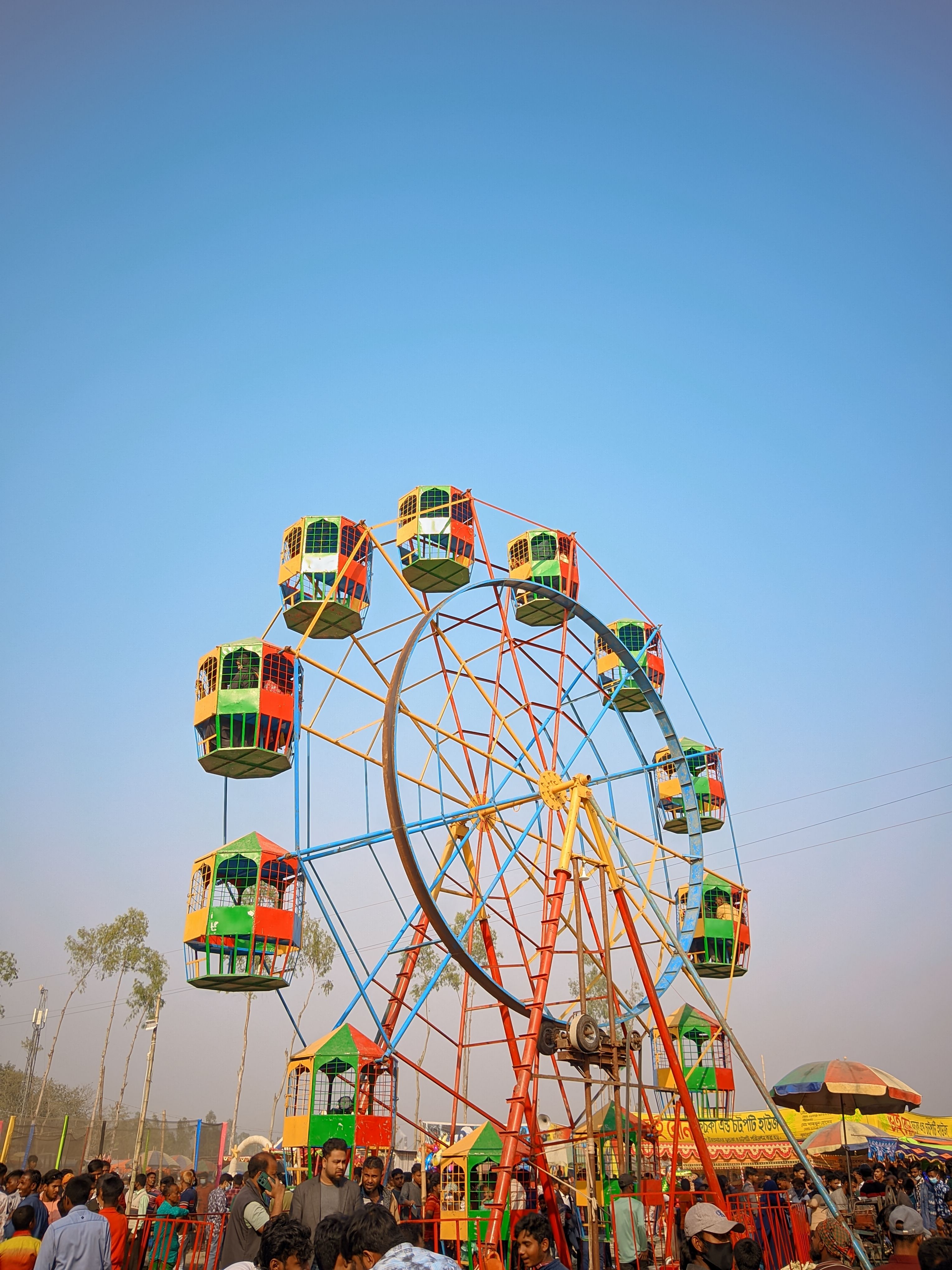 Colorful Ferris Wheel at Outdoor Fair in Bangladesh · Free Stock Photo