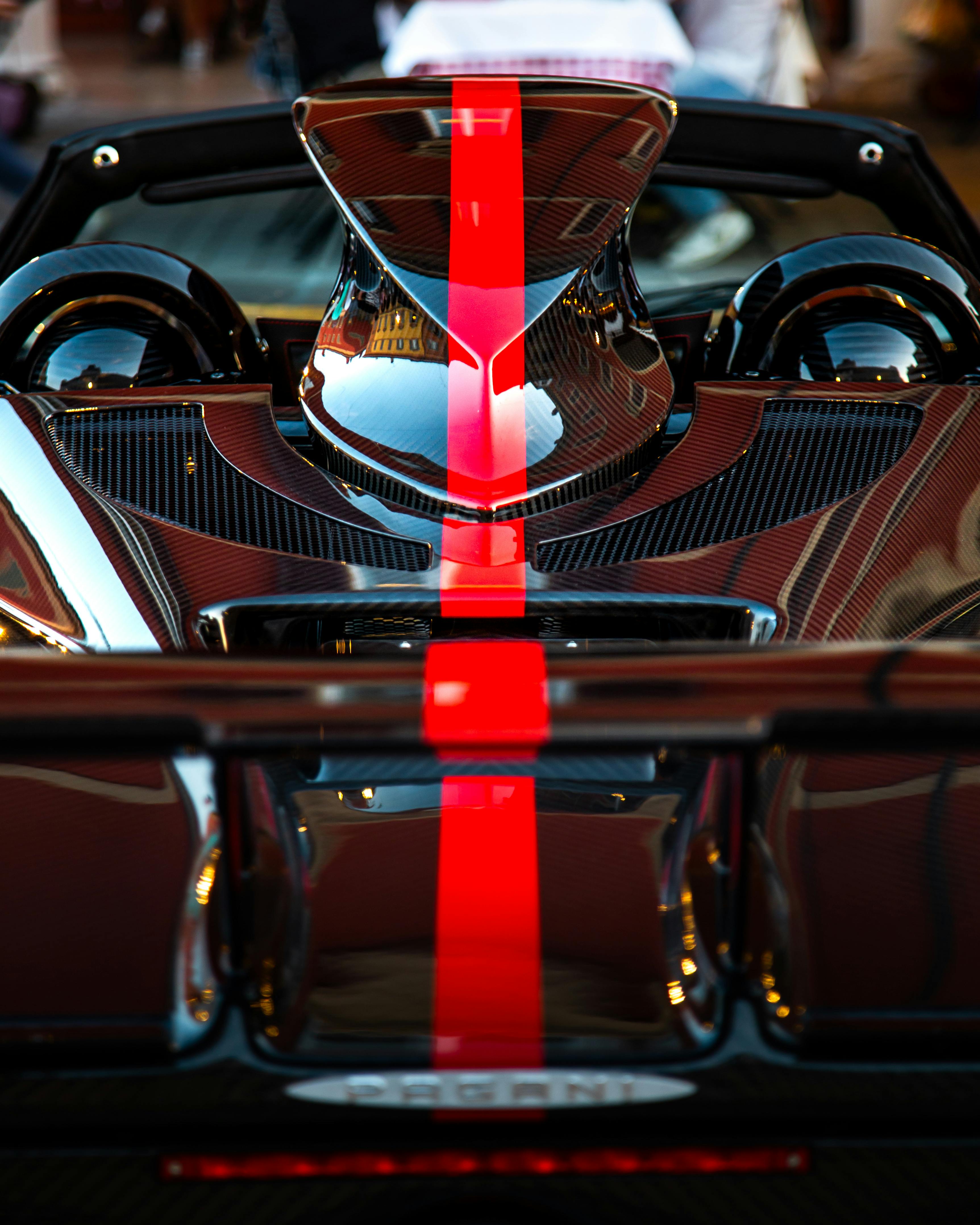 Sleek Rear View of Luxury Red-Striped Sports Car · Free Stock Photo