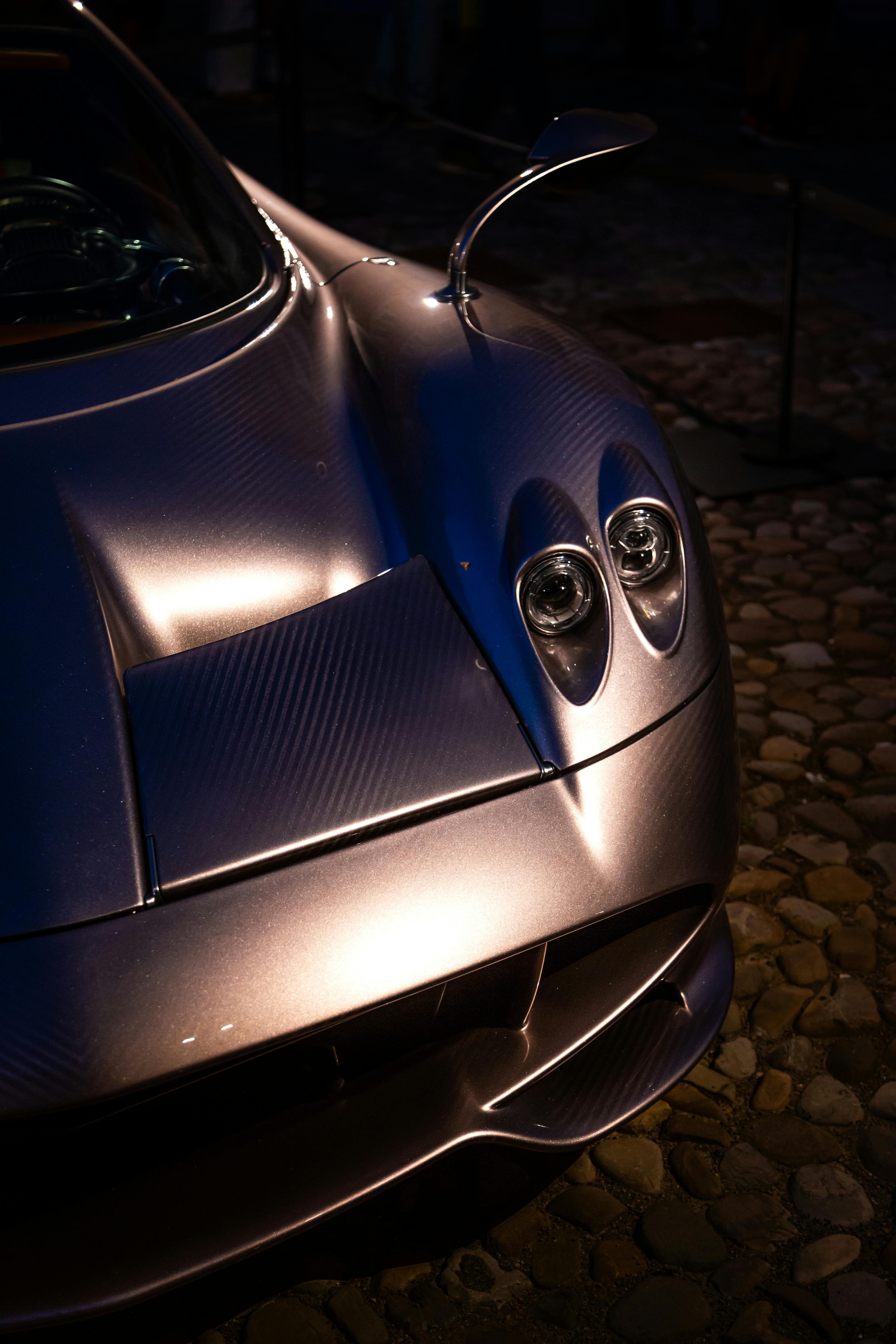 Sleek Supercar Headlight Close-Up at Exhibition · Free Stock Photo