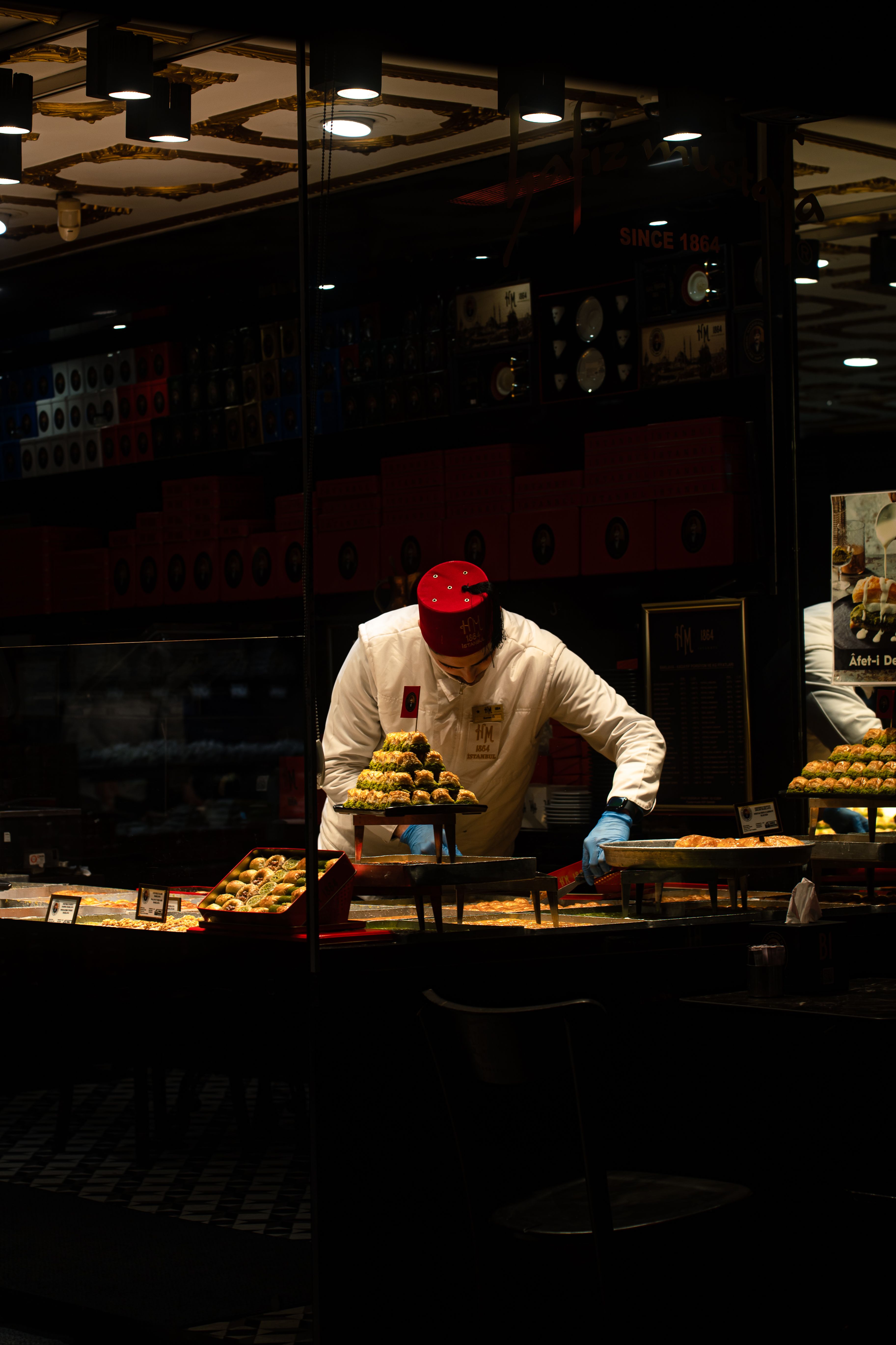 Pastry Chef Preparing Desserts in Dimly Lit Bakery · Free Stock Photo