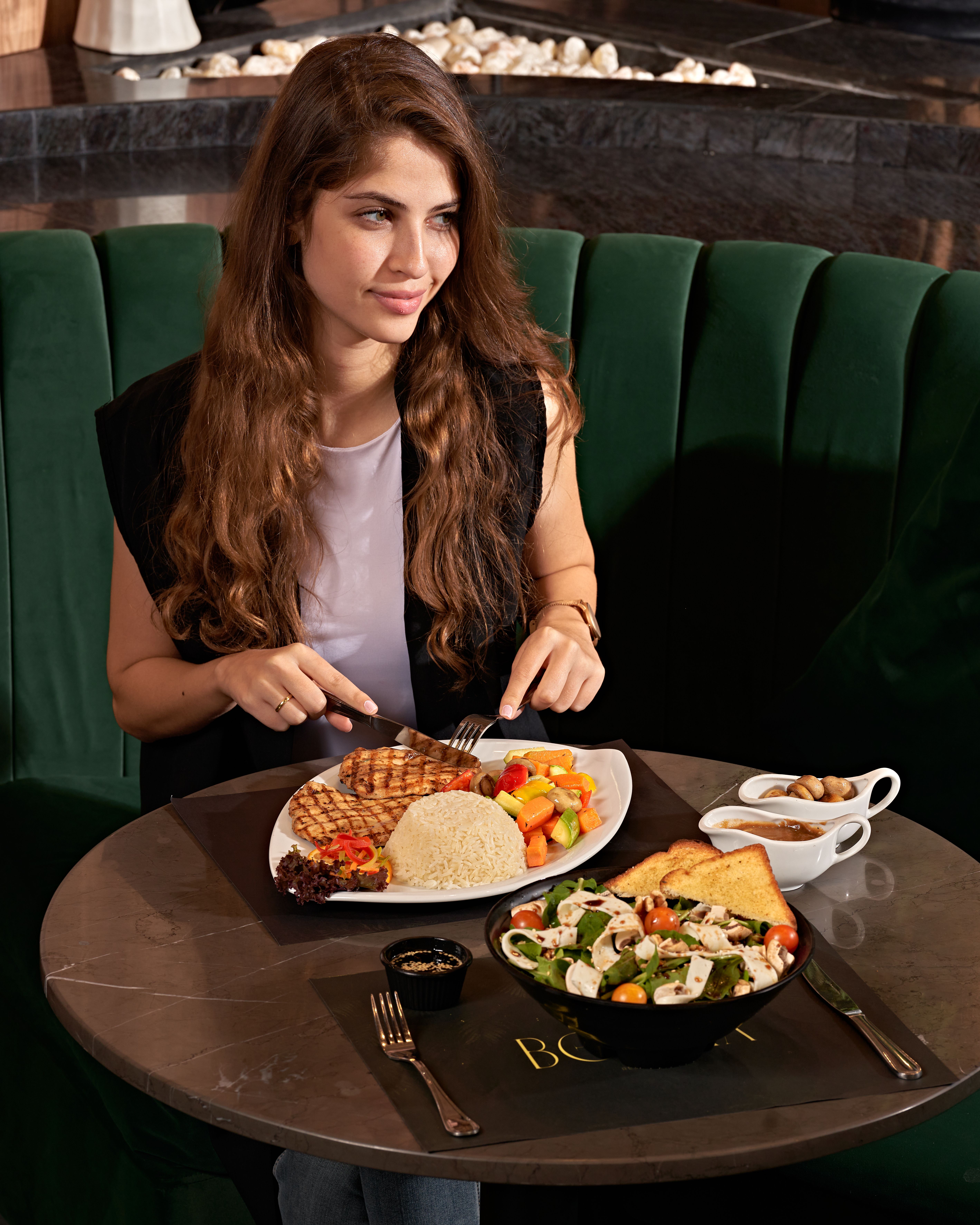 Woman Dining in a Cozy Restaurant Setting · Free Stock Photo