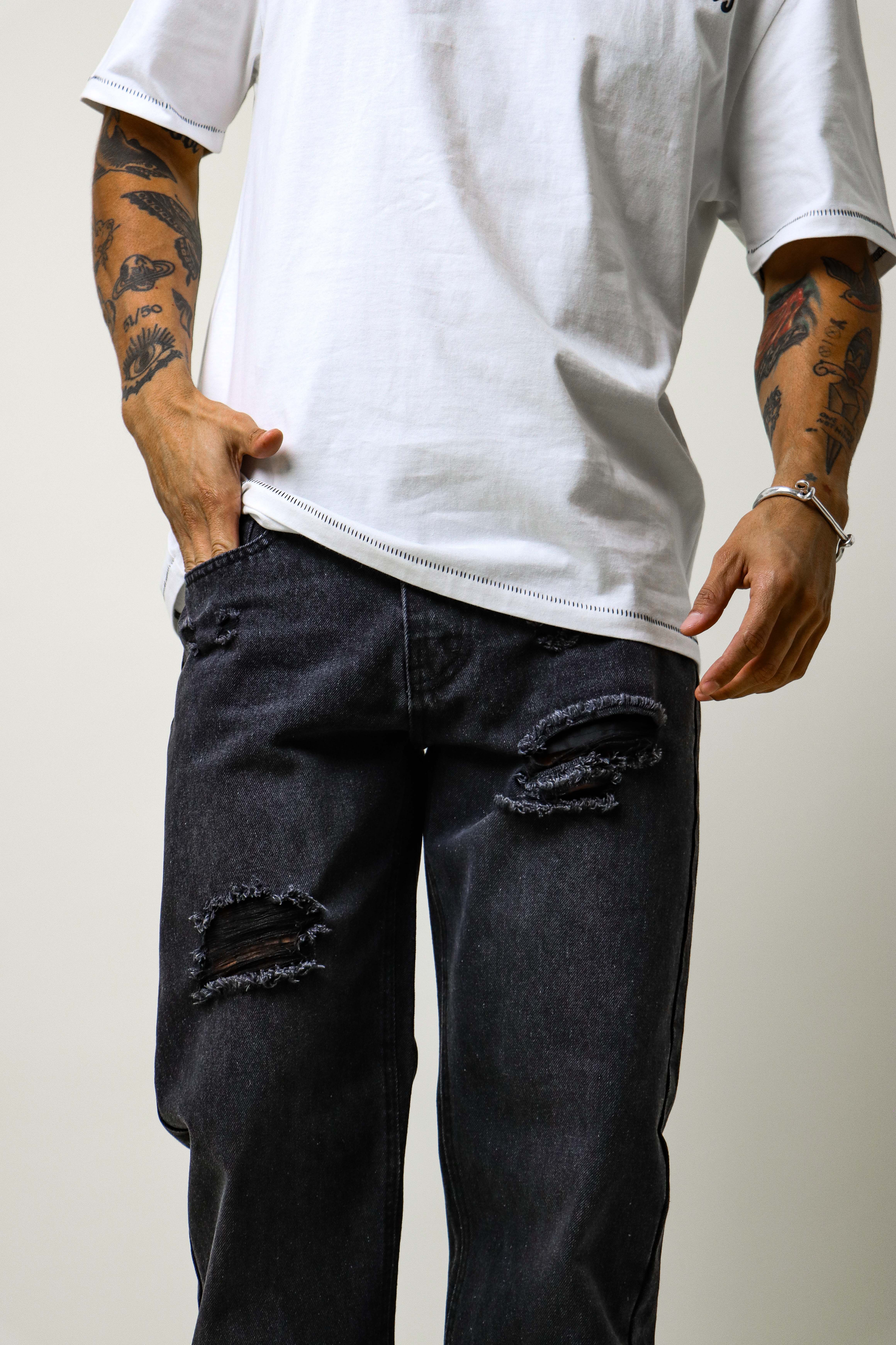Casual Style with Tattooed Arms in Ripped Jeans · Free Stock Photo