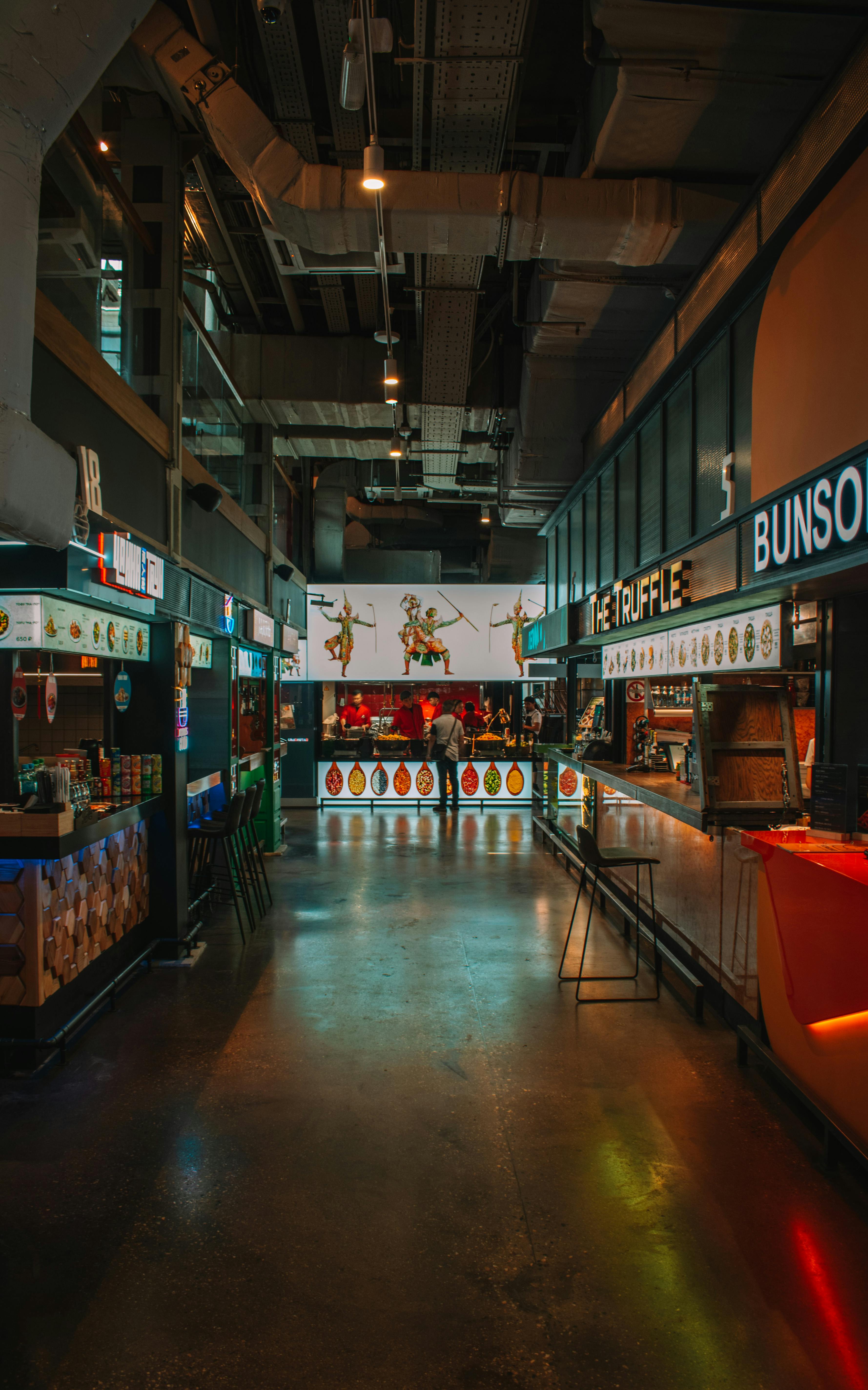 Vibrant Indoor Food Court with Colorful Stalls · Free Stock Photo