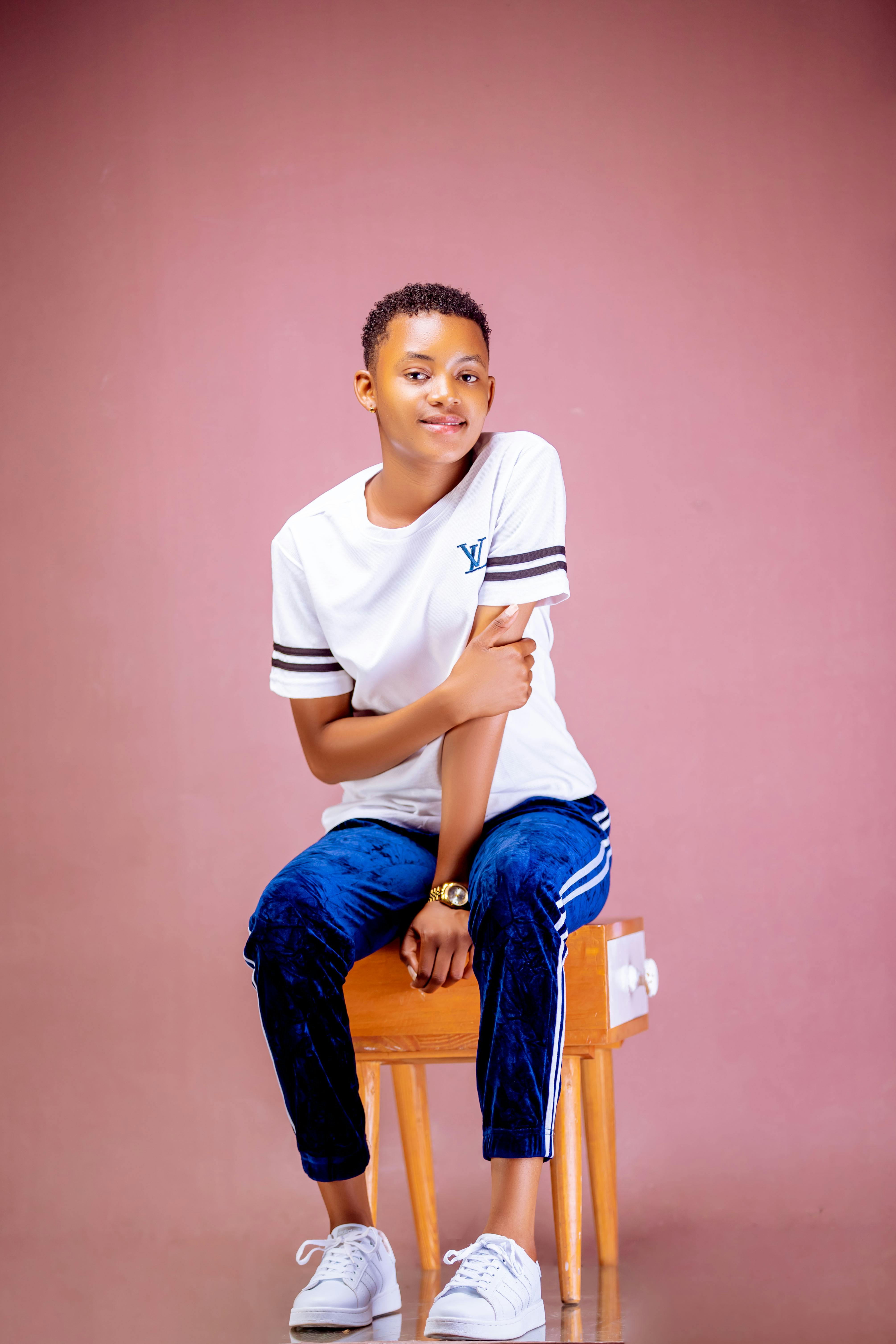 Stylish Teenager Posing on a Stool Indoors · Free Stock Photo