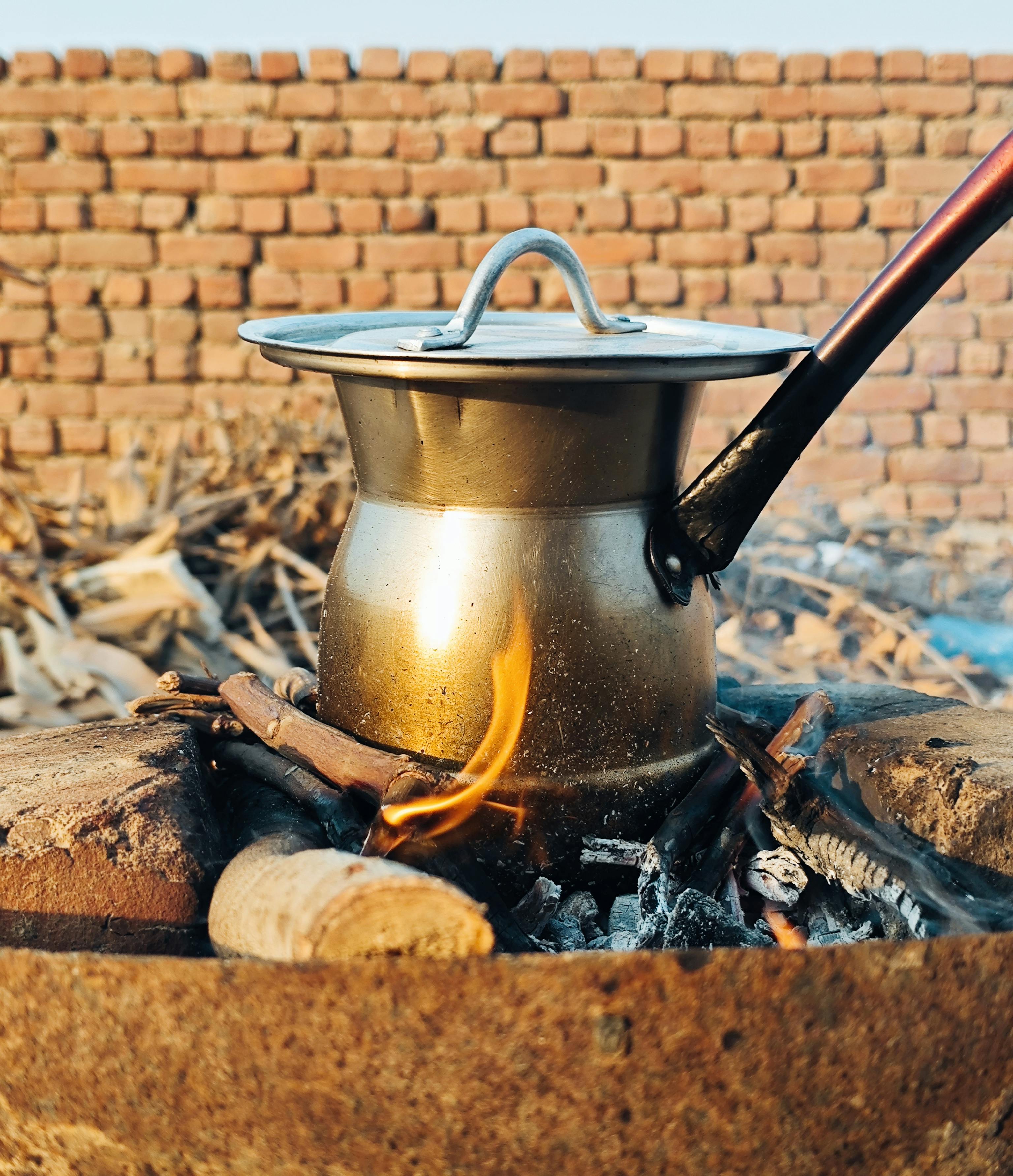 Rustic Outdoor Cooking with Firewood and Pot · Free Stock Photo